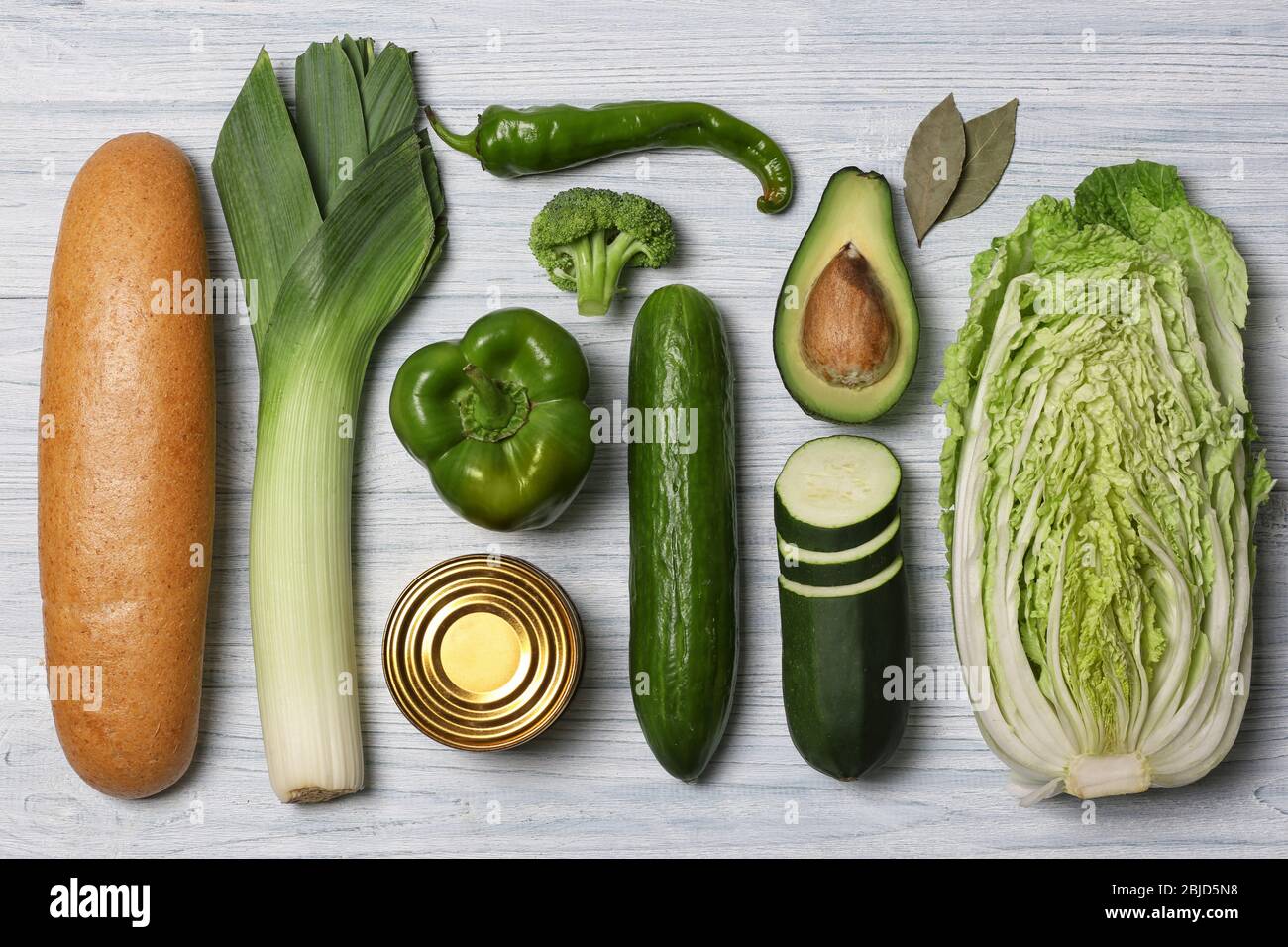 Variety of food products on kitchen table Stock Photo - Alamy
