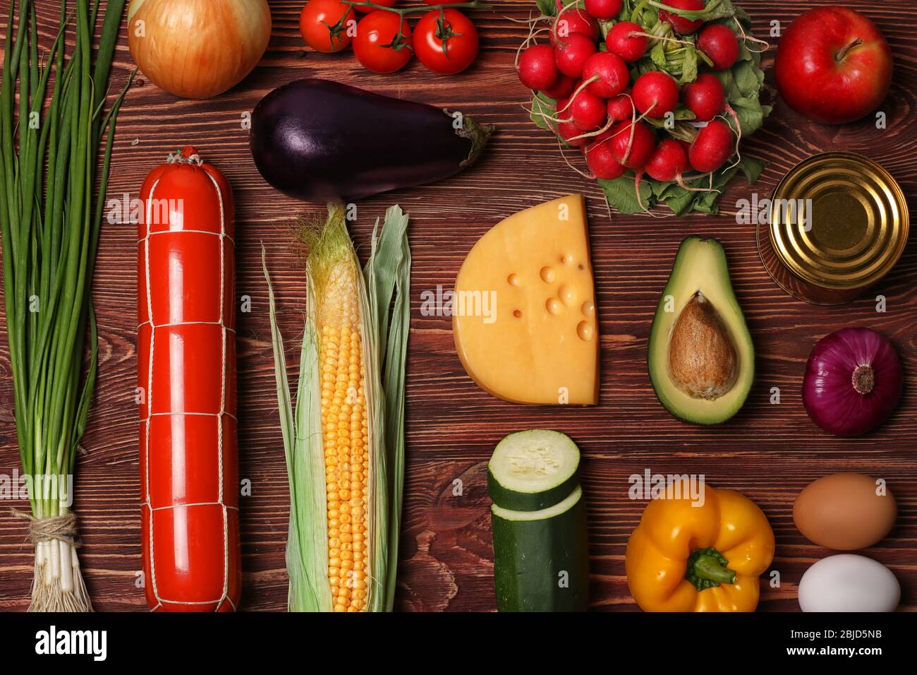 Variety of food products on kitchen table Stock Photo - Alamy