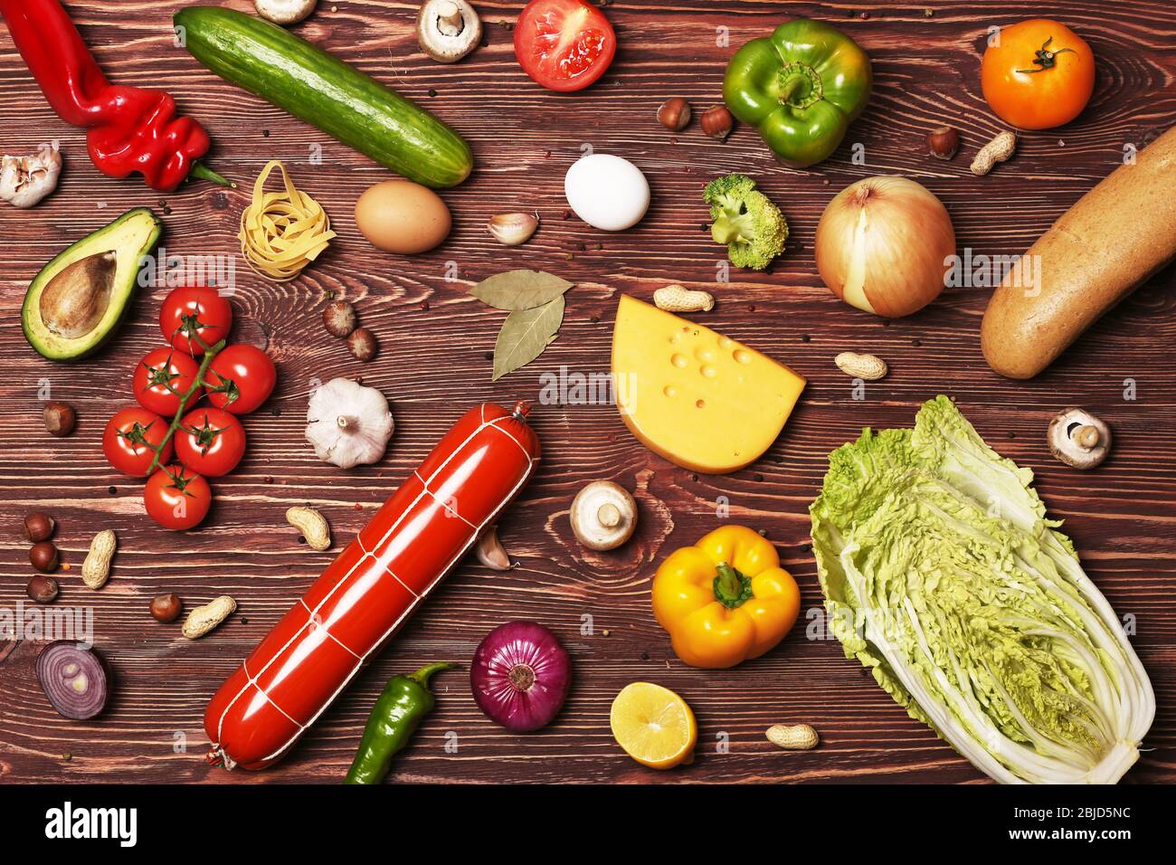 Variety of food products on kitchen table Stock Photo - Alamy