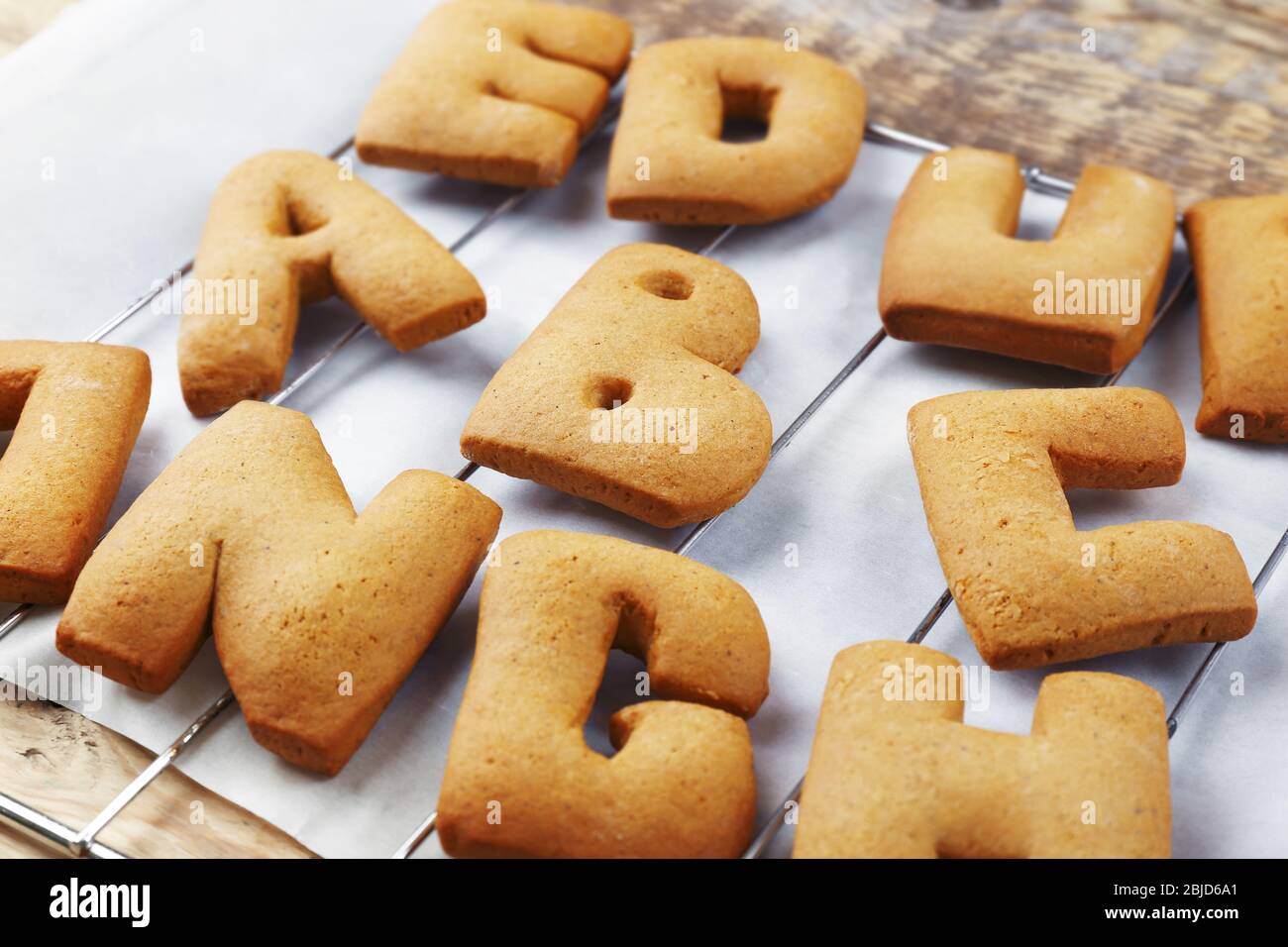 Cookie alphabet on grid, closeup Stock Photo - Alamy