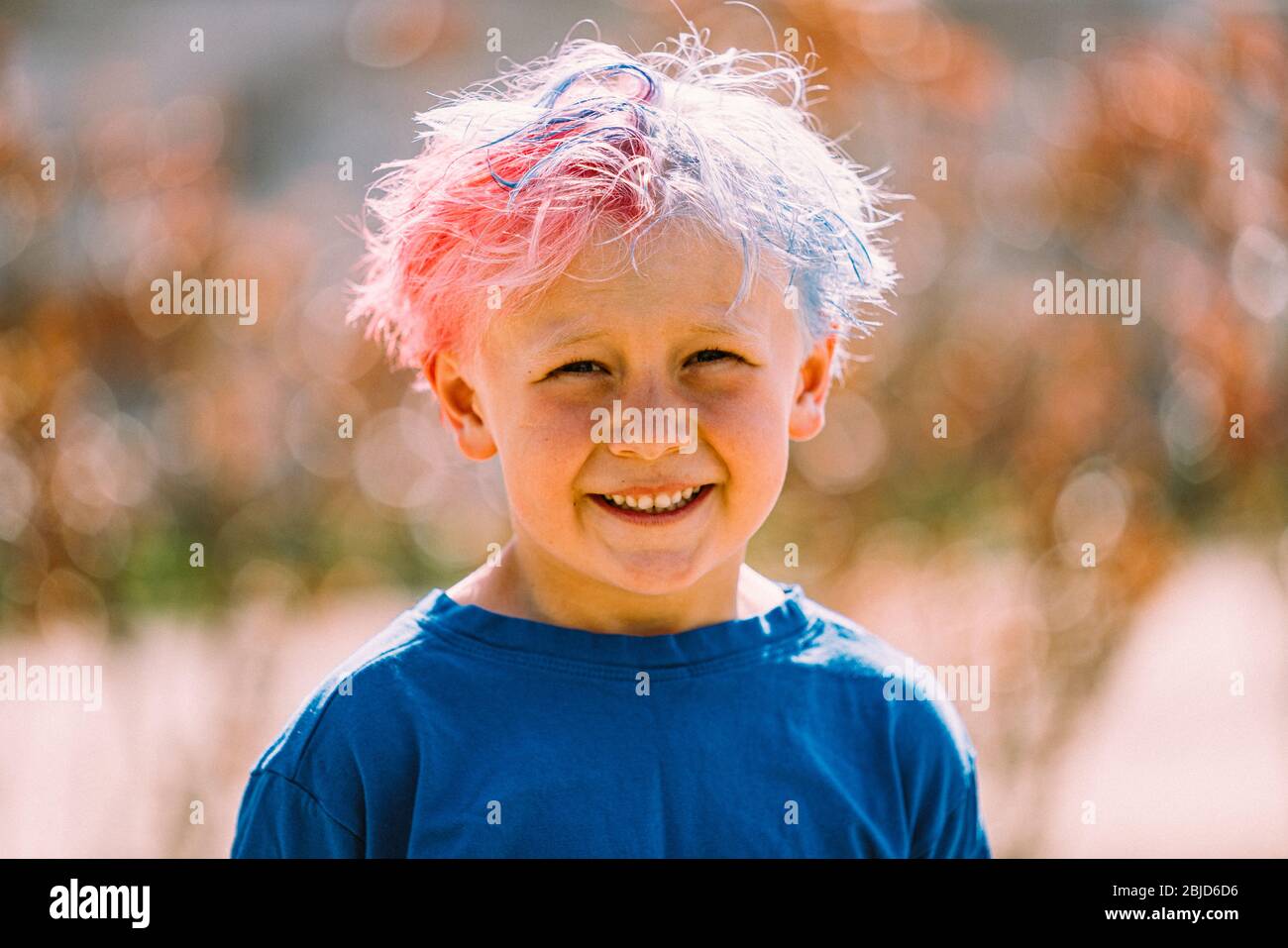 Portrait of young boy with colored hair smiling at camera Stock Photo ...