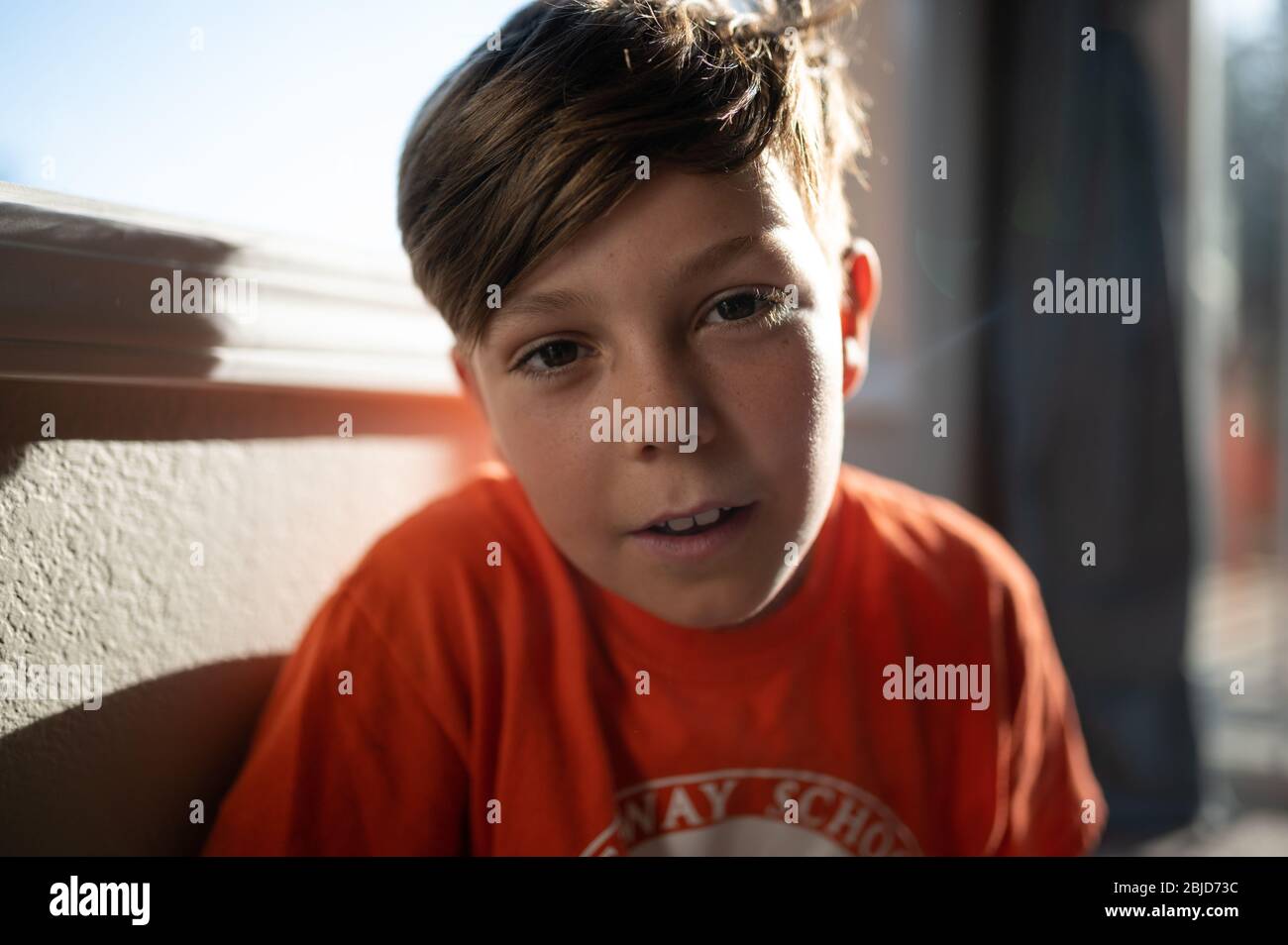 Portrait of a boy inside looking at the camera with beautiful light ...