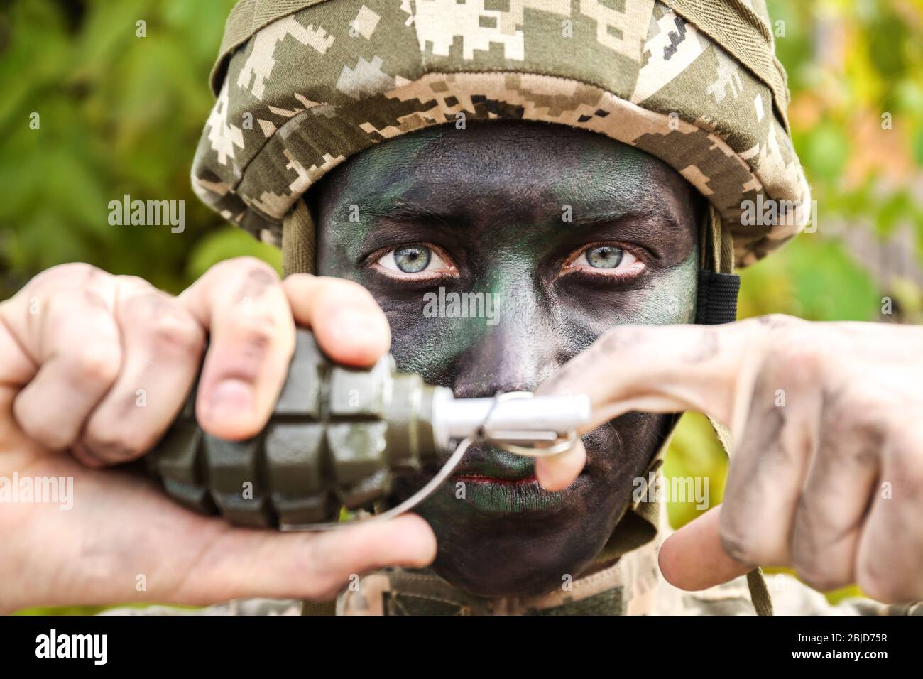 Close up view of soldier pulling safety pin out of fragmentation ...