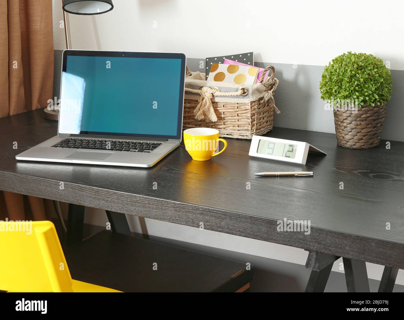 Workplace with laptop on desk in modern room Stock Photo - Alamy