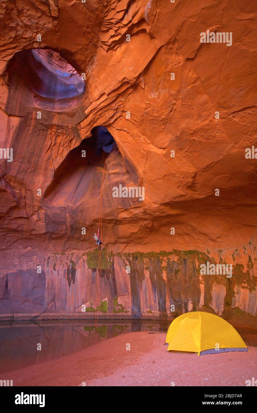 man rappelling into cave at Escalante's giant staircase Stock Photo - Alamy