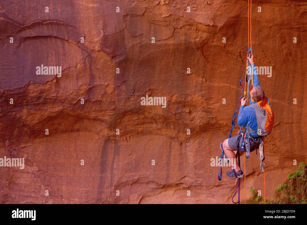 man rappelling into cave at Escalante's giant staircase Stock Photo - Alamy