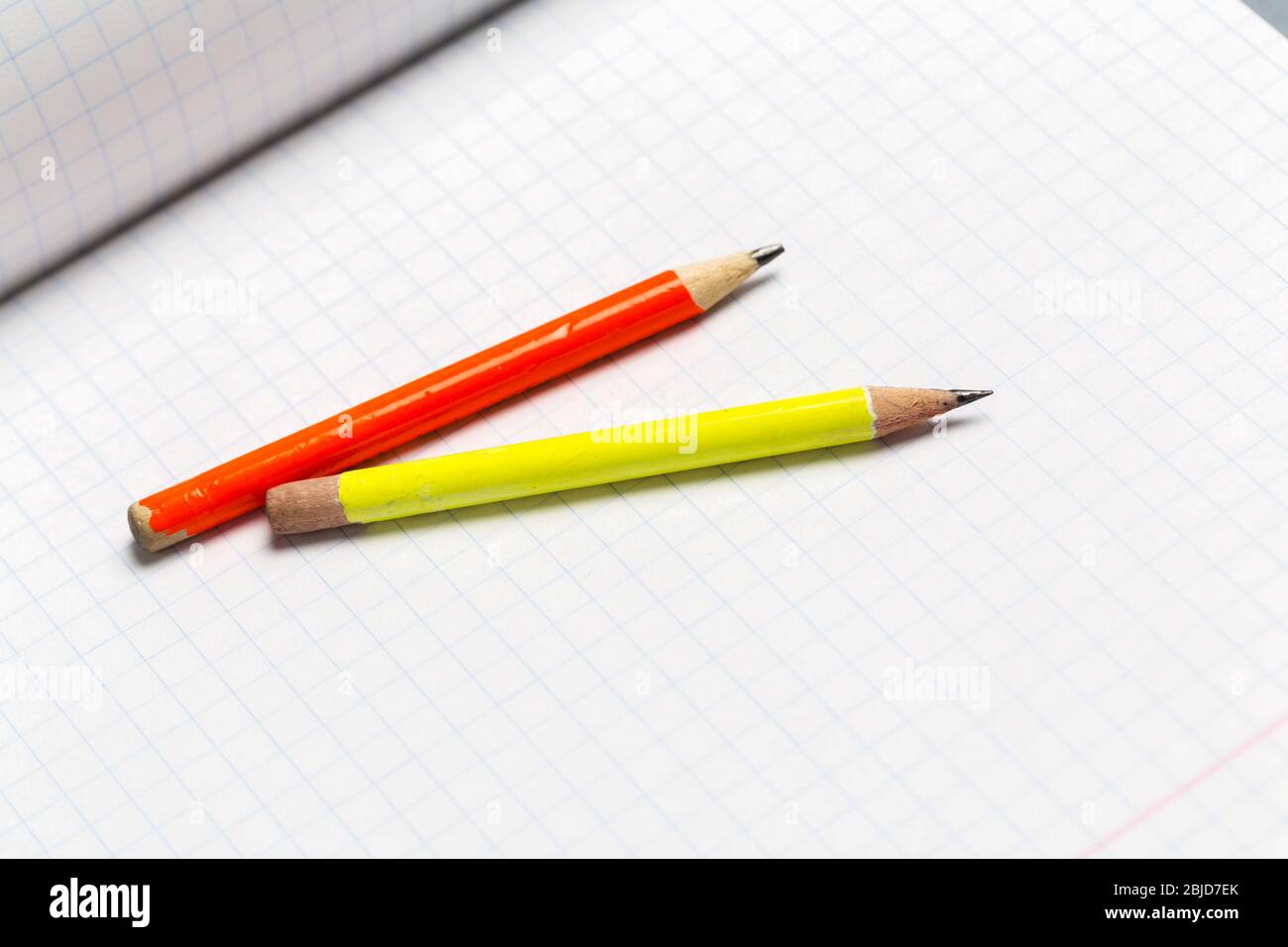 Pencils and notepad paper sheets on gray desk table Stock Photo - Alamy