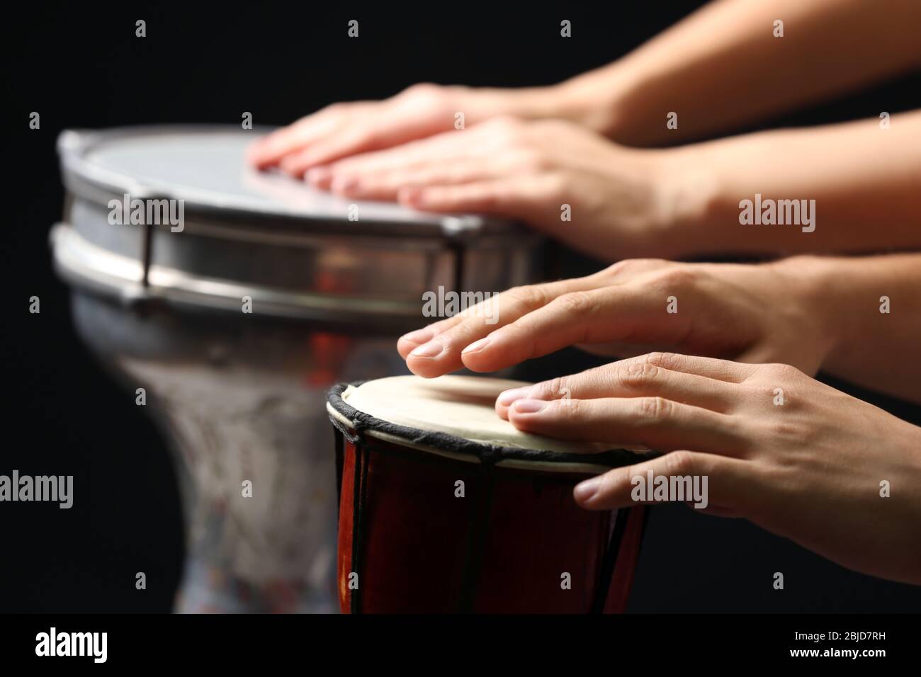 Hands of man playing African drum on dark background, close up Stock ...