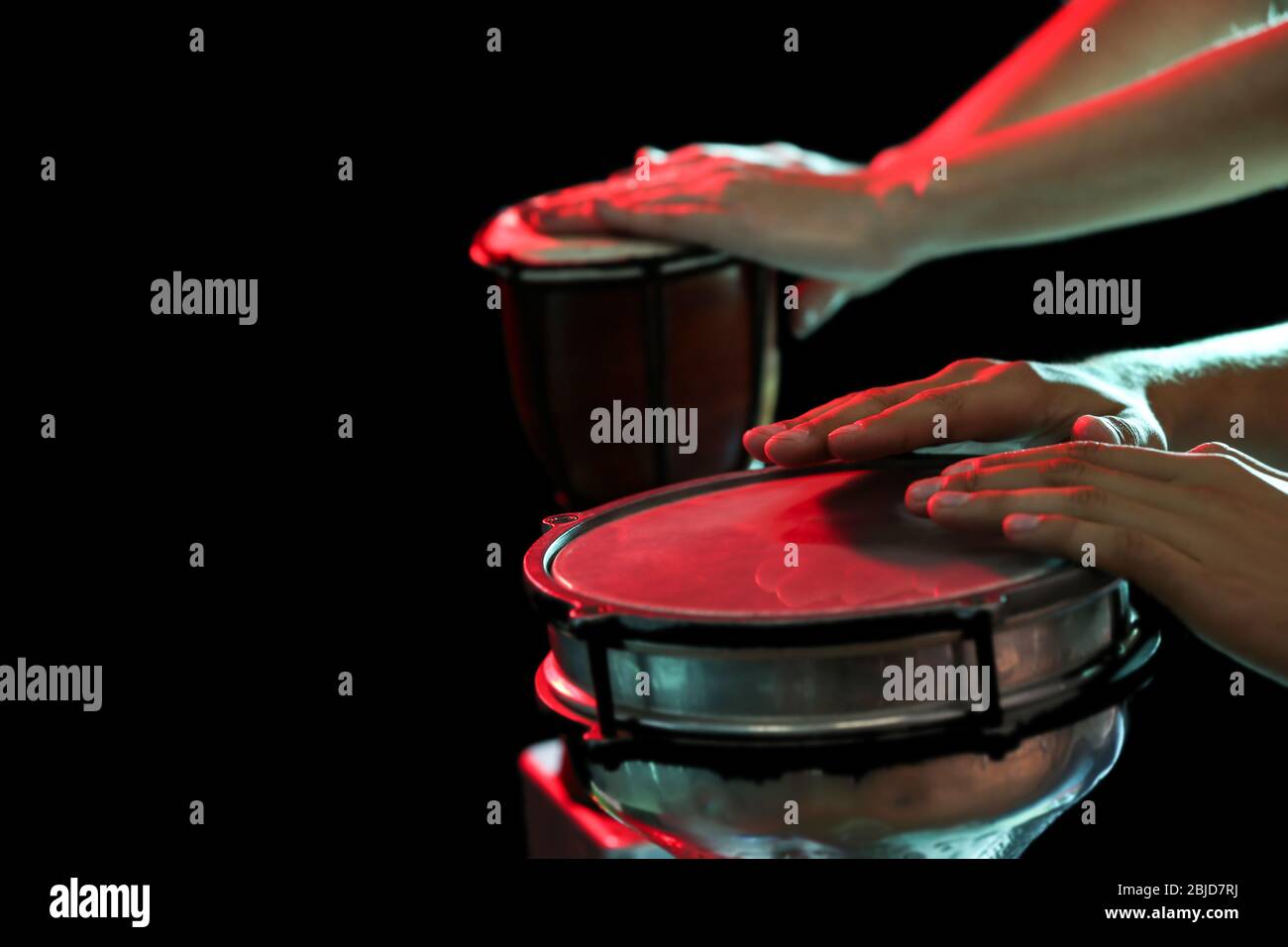 Hands of man playing African drum on dark background Stock Photo - Alamy