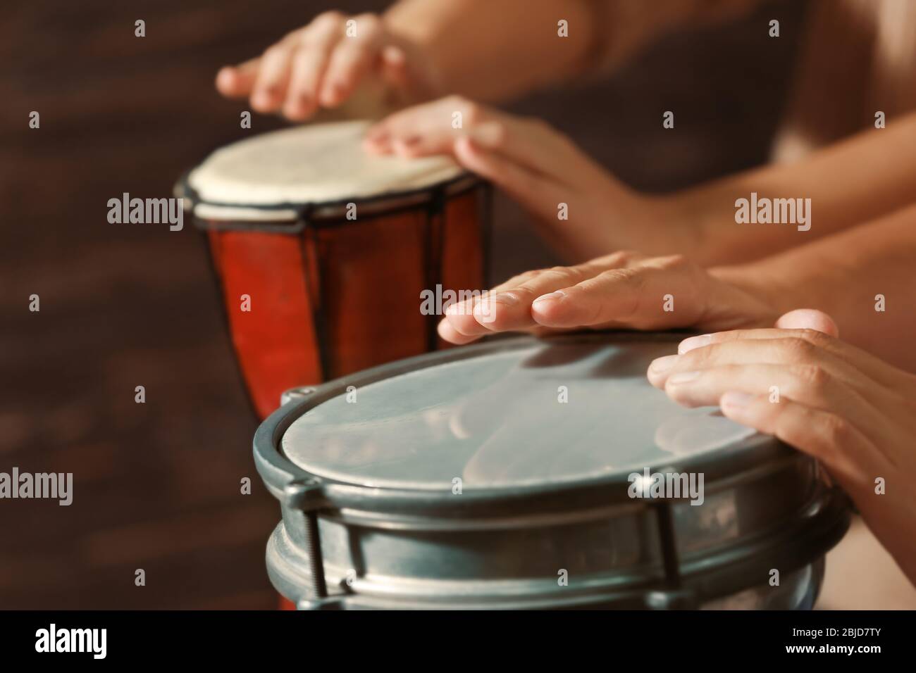 Hands of man playing African drum on dark background Stock Photo - Alamy