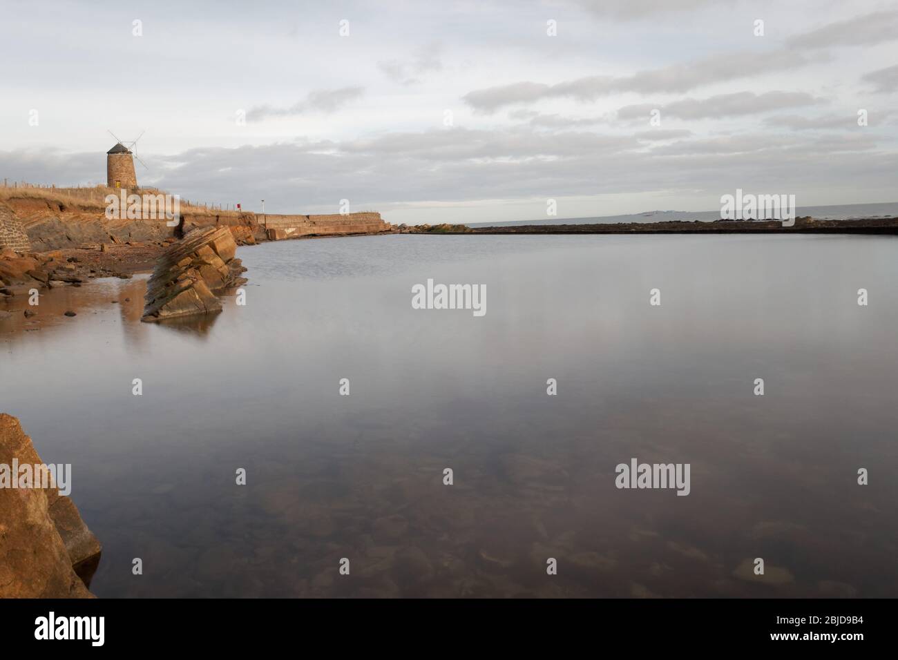 The tidal pool and windmill in St.Monans Fife, Scotland. UK Stock Photo ...