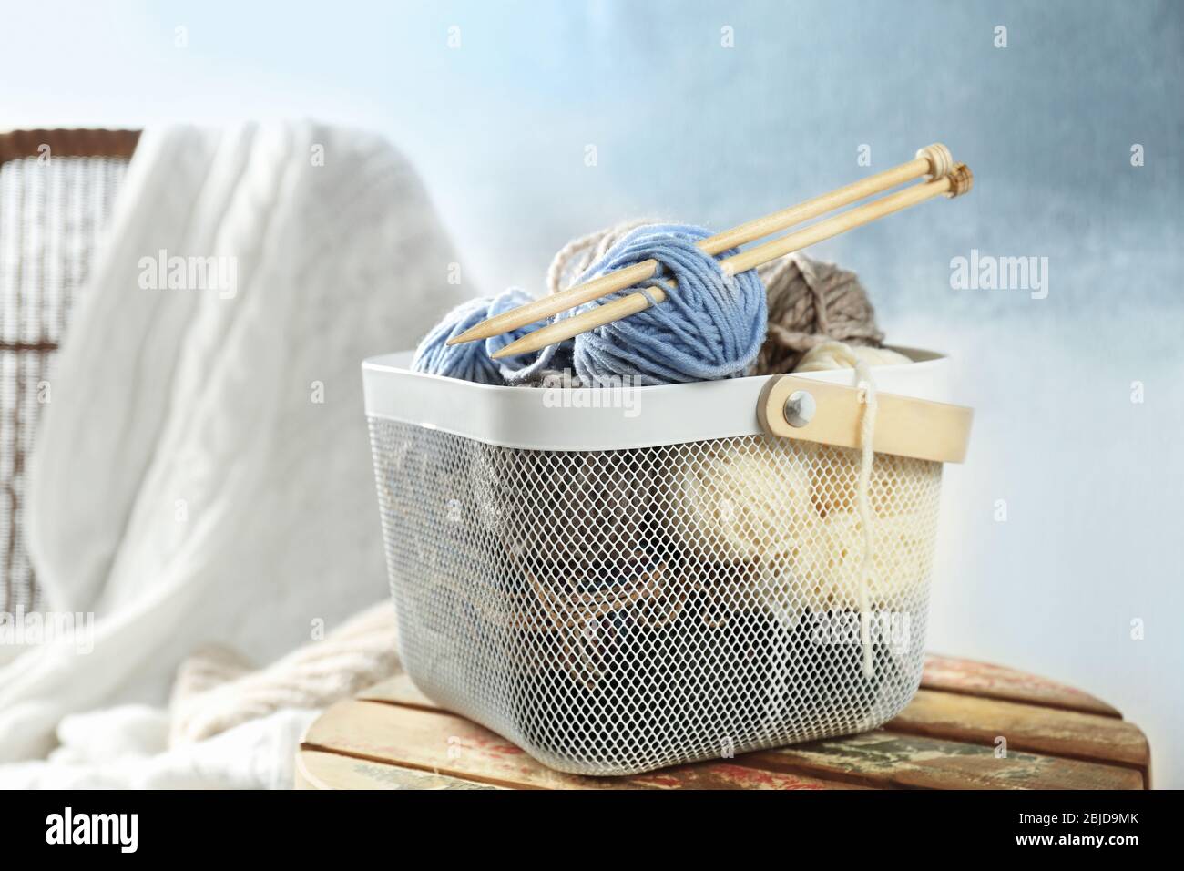 Plastic box with knitting yarn and needles on stool Stock Photo - Alamy