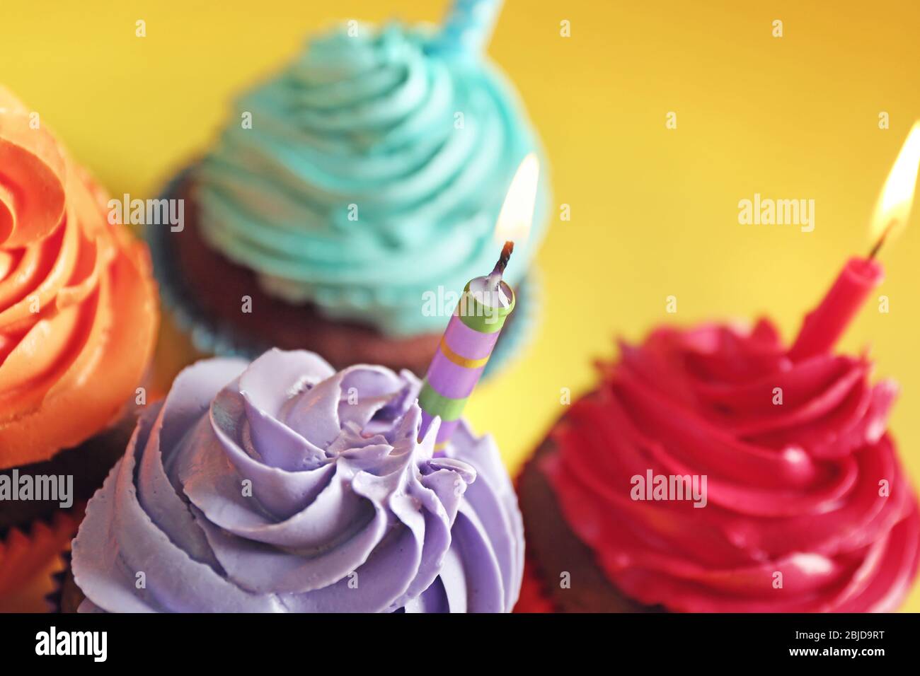 Birthday cupcakes with candles, closeup Stock Photo - Alamy