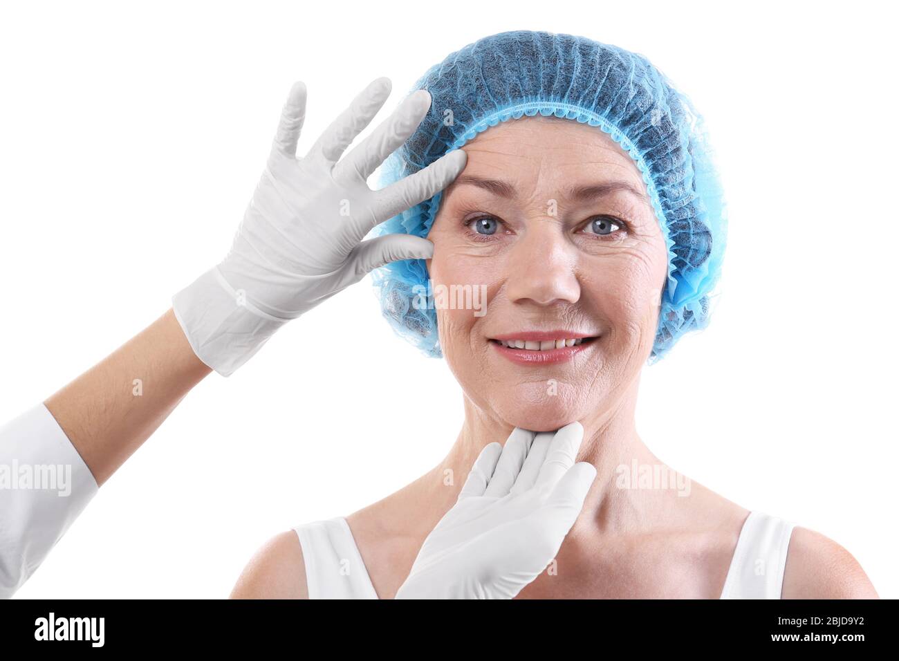 Surgeon examining female patient on white background Stock Photo - Alamy