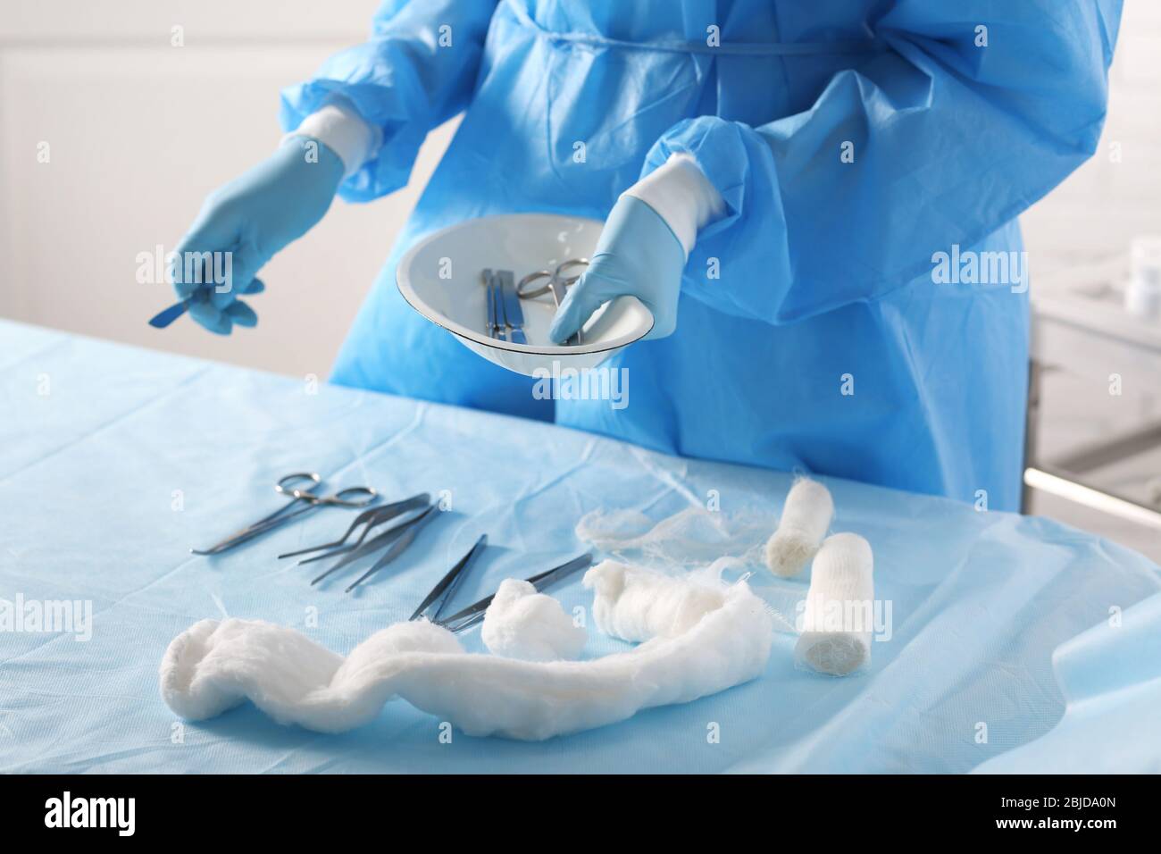 Surgeon with tools on table Stock Photo - Alamy