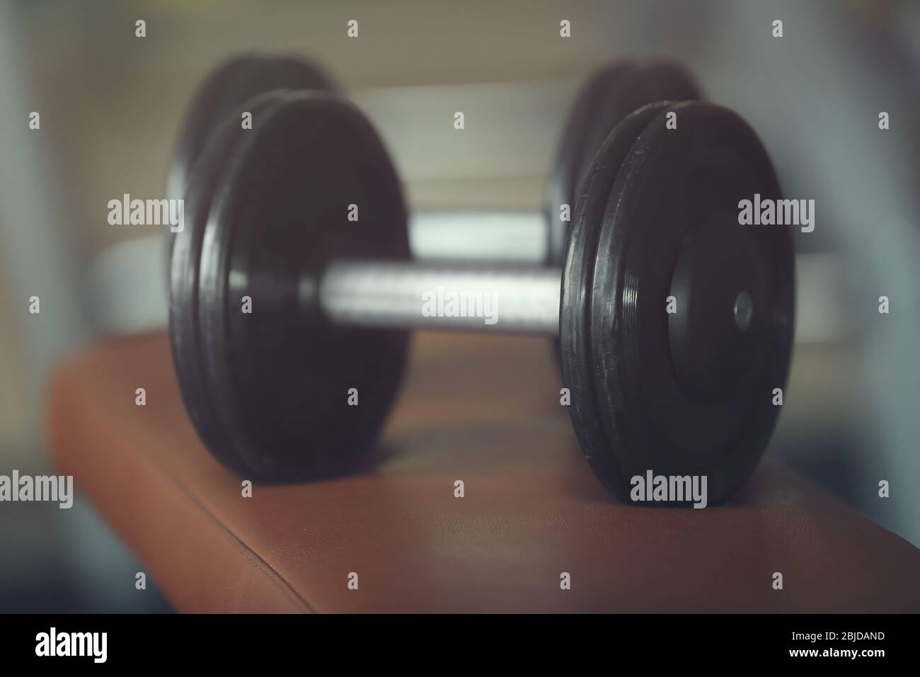 Dumbbells on background blurred hi-res stock photography and images - Alamy
