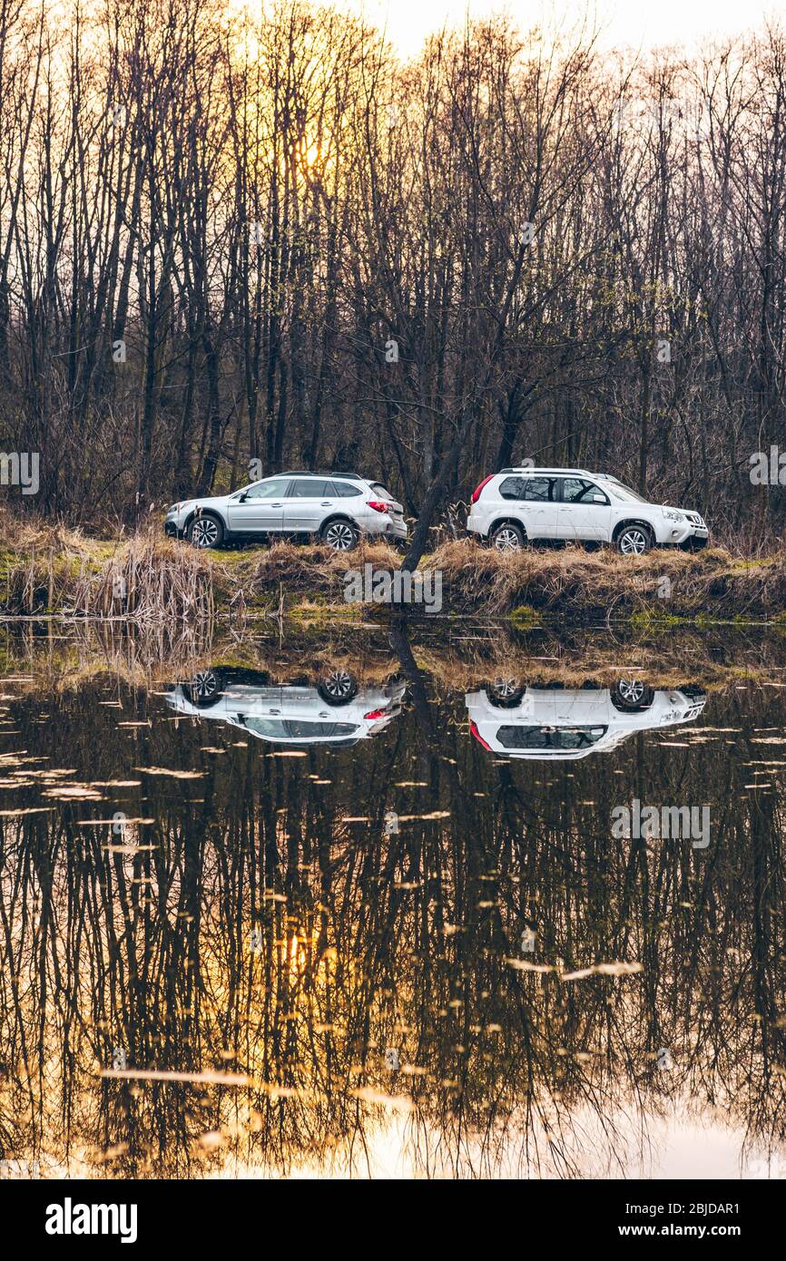 two suv car in forest. foot path Stock Photo - Alamy