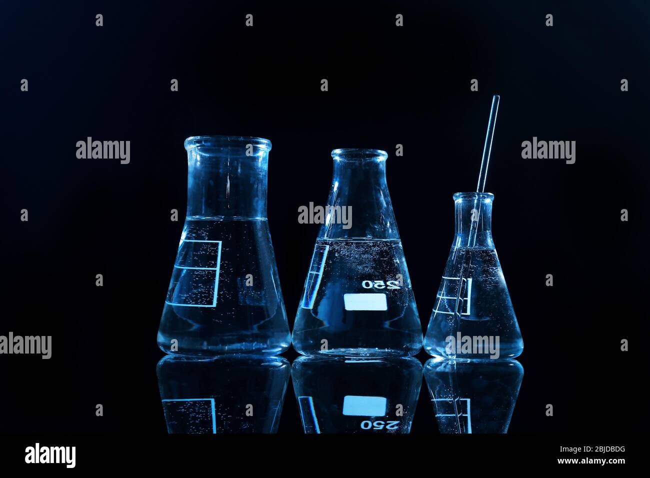 Test beakers and flasks on dark background Stock Photo - Alamy