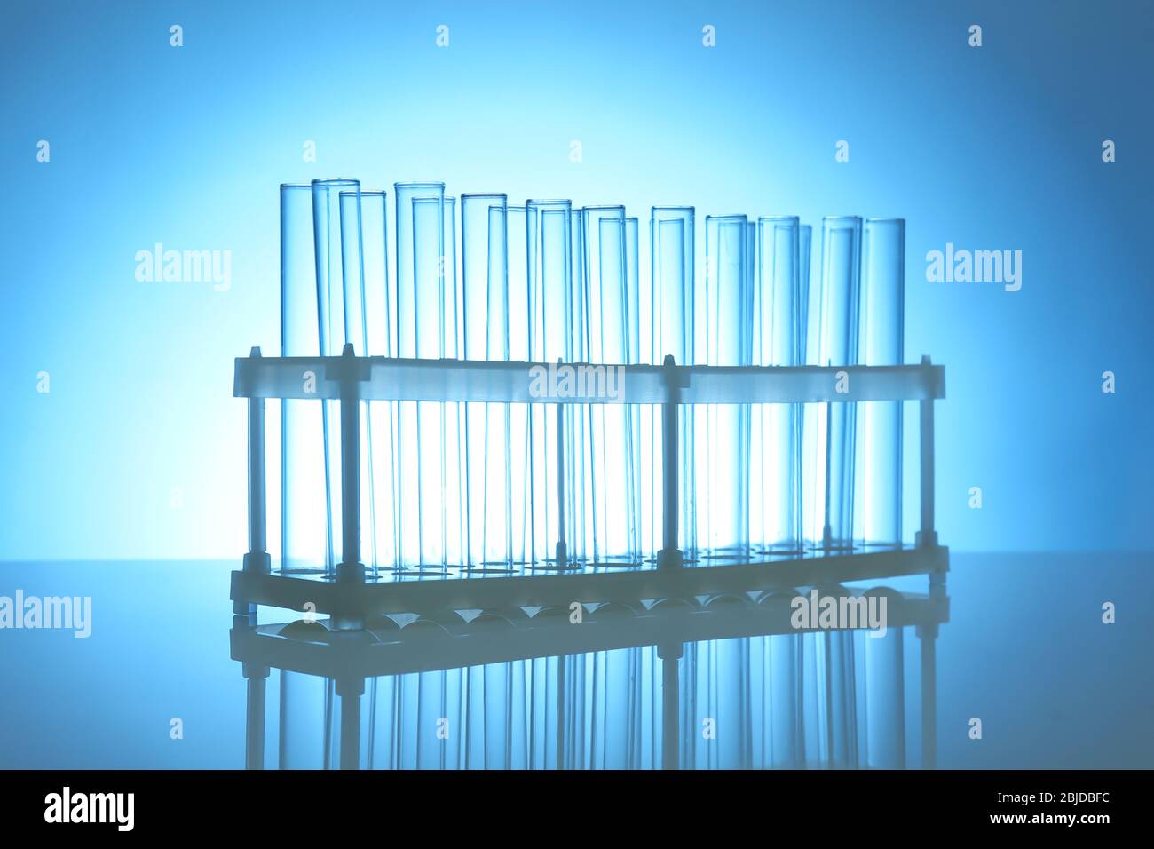 Test tubes on colour background Stock Photo - Alamy