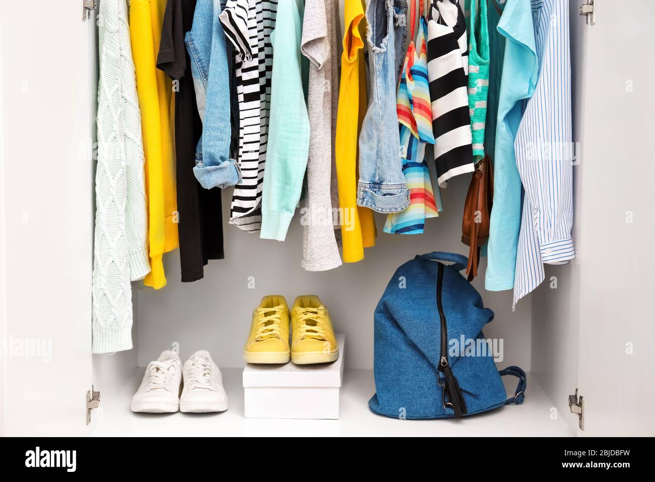 Collection of clothes hanging on a rack Stock Photo - Alamy