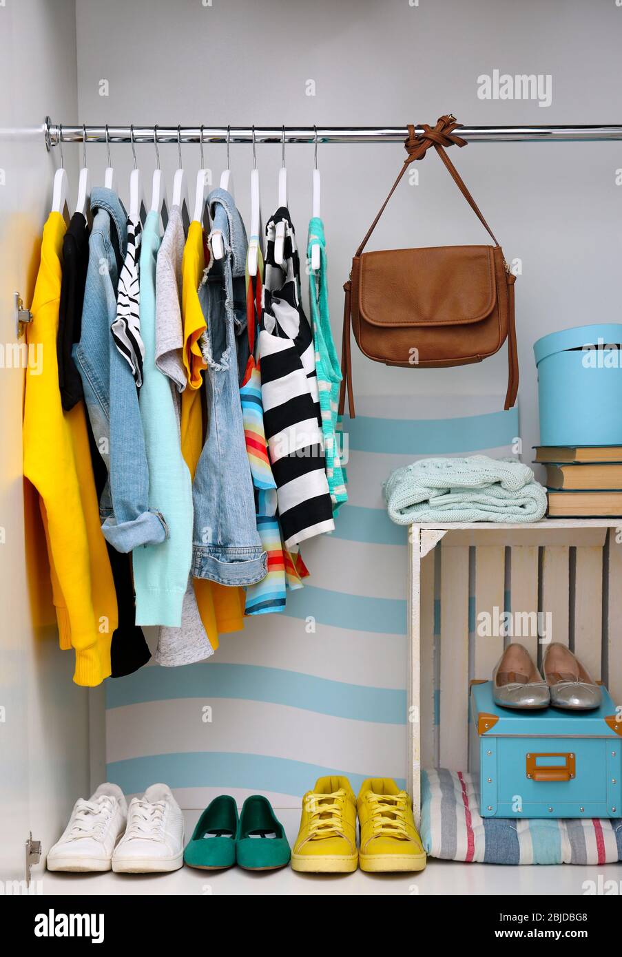 Collection of clothes hanging on a rack Stock Photo - Alamy