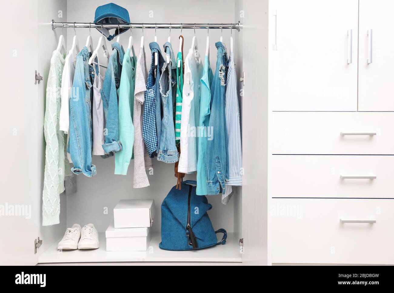 Collection of clothes hanging on a rack Stock Photo - Alamy