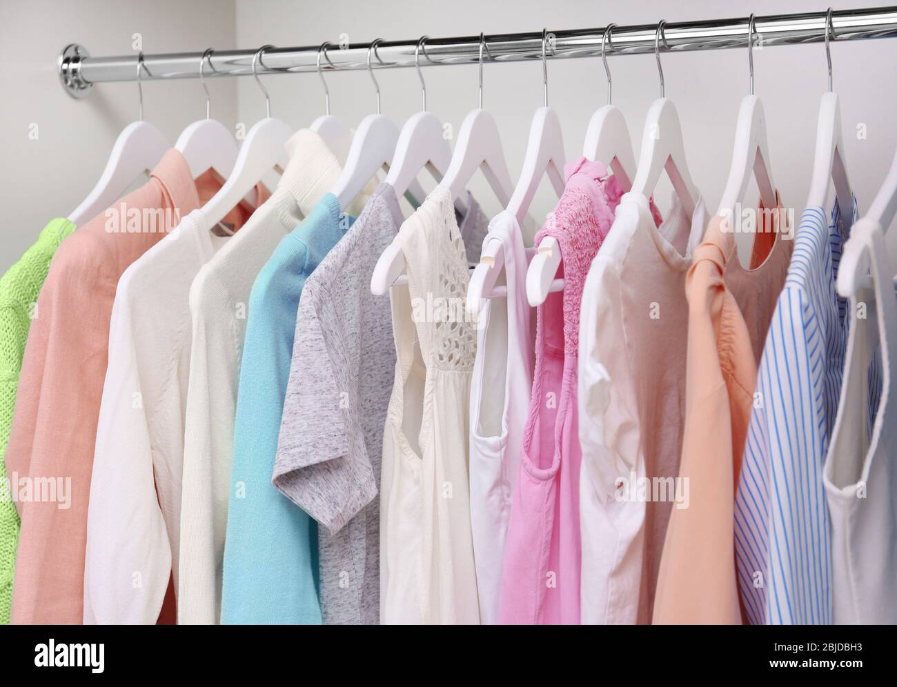 Collection of clothes hanging on a rack Stock Photo - Alamy