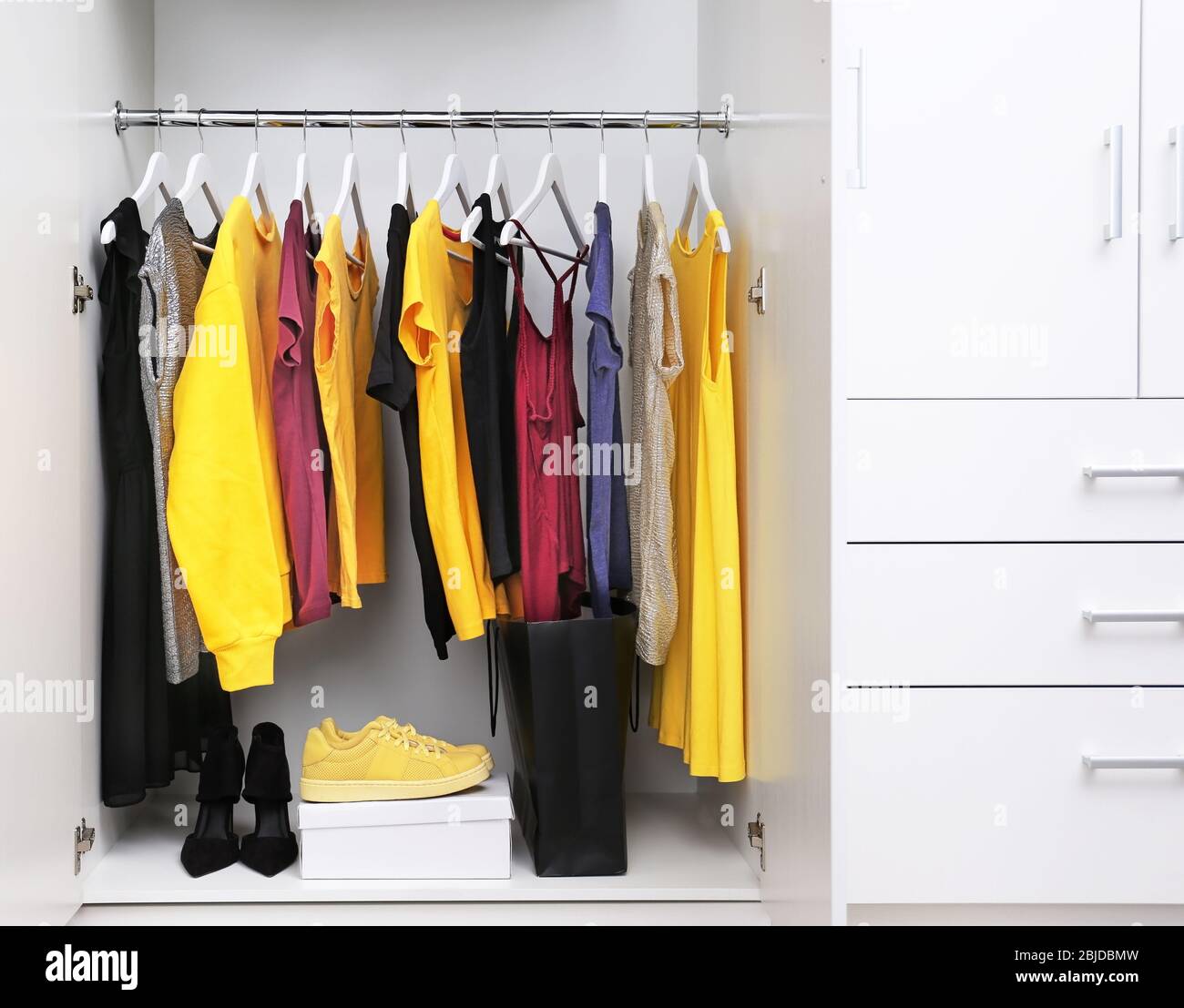 Collection of clothes hanging on a rack Stock Photo - Alamy