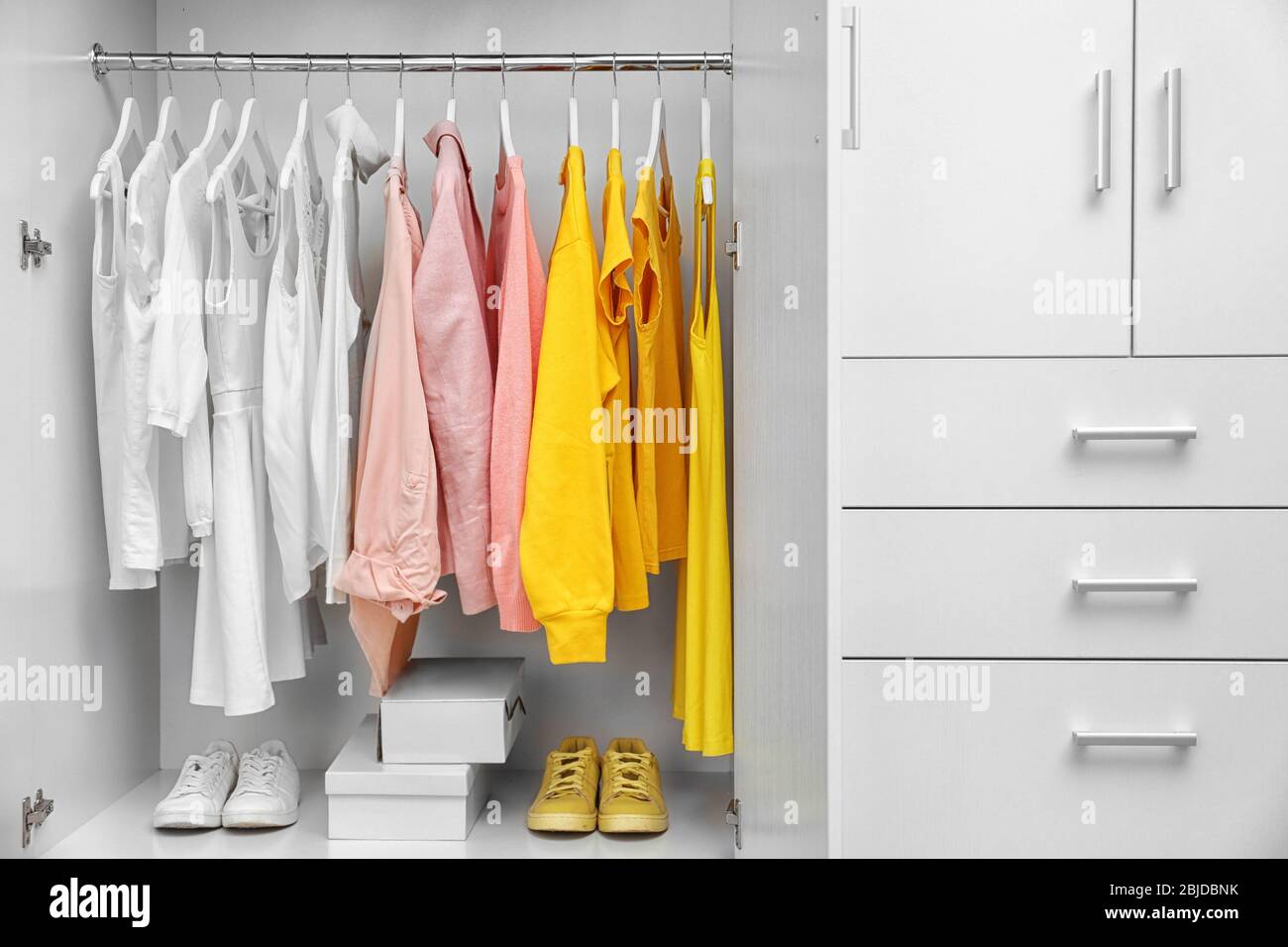 Collection of clothes hanging on a rack Stock Photo - Alamy