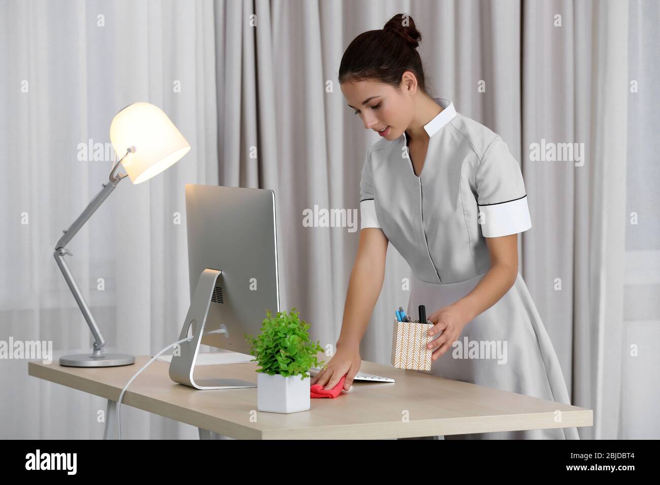 Female chambermaid cleaning in hotel room Stock Photo - Alamy