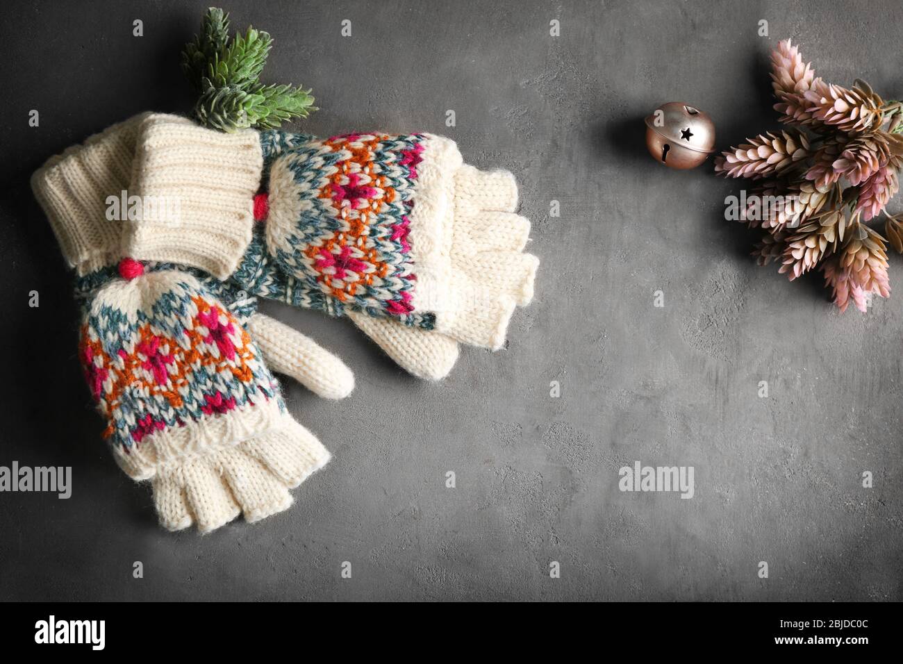 Knitted mittens and decor on color background Stock Photo - Alamy