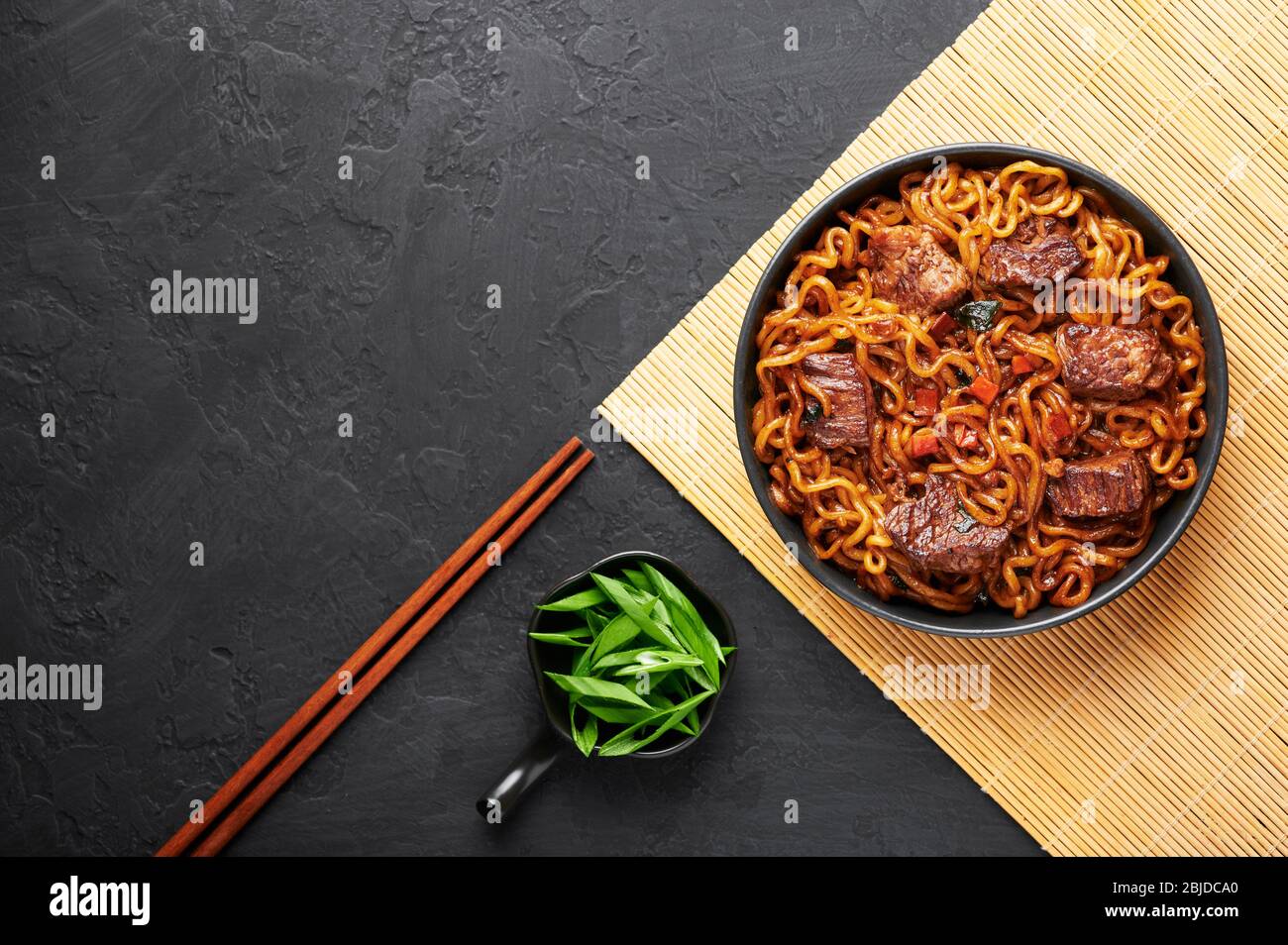 Ram-Don or Chapaguri noodles with beef steak in black bowl on dark ...