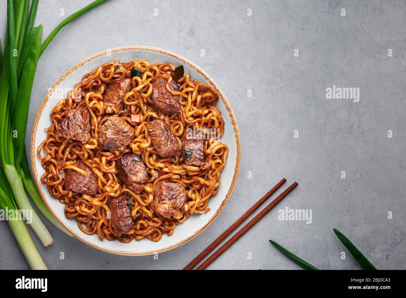 Ram-Don or Chapaguri noodles with beef steak in white bowl on grey ...
