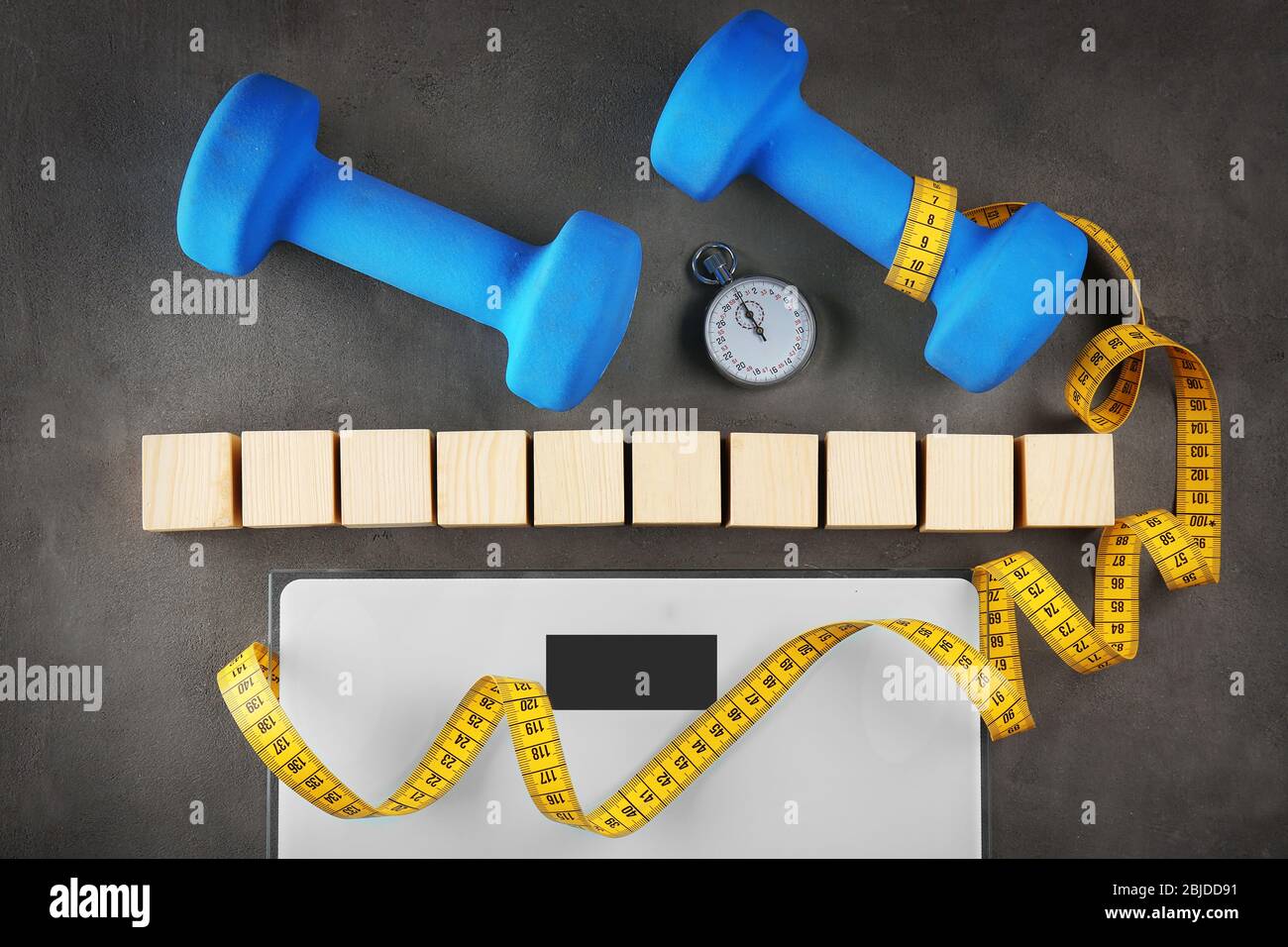 Measure tape, scales and wooden cubes with space for text on grey ...