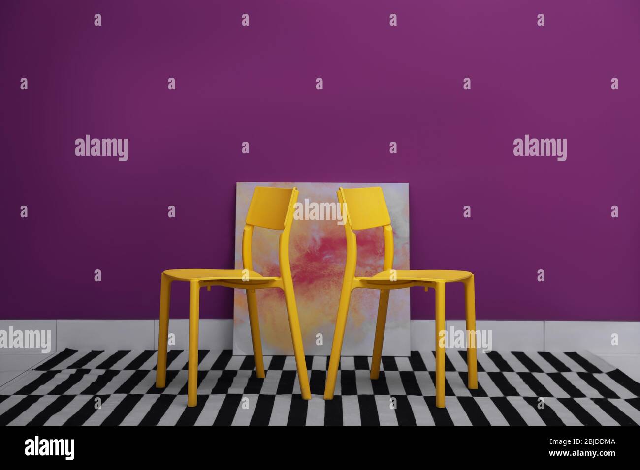 Modern chairs on wall background Stock Photo - Alamy