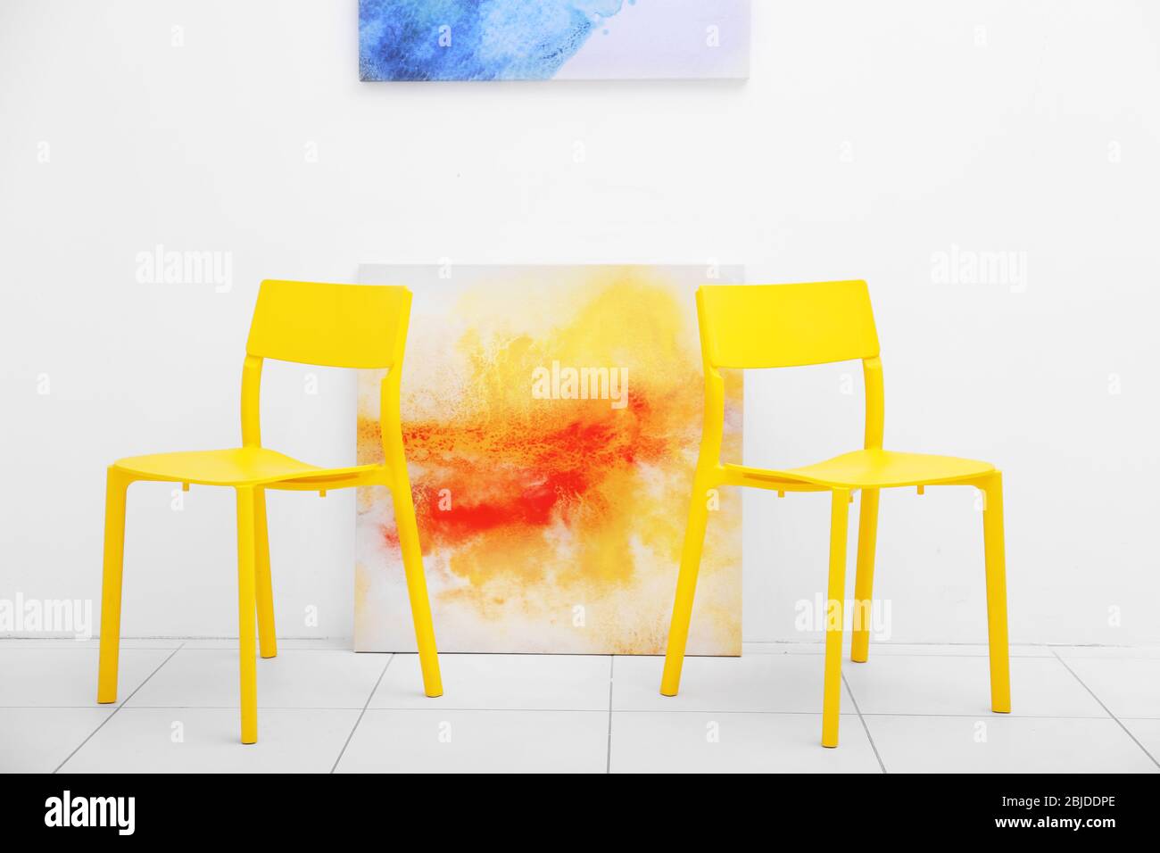 Modern chairs on wall background Stock Photo - Alamy