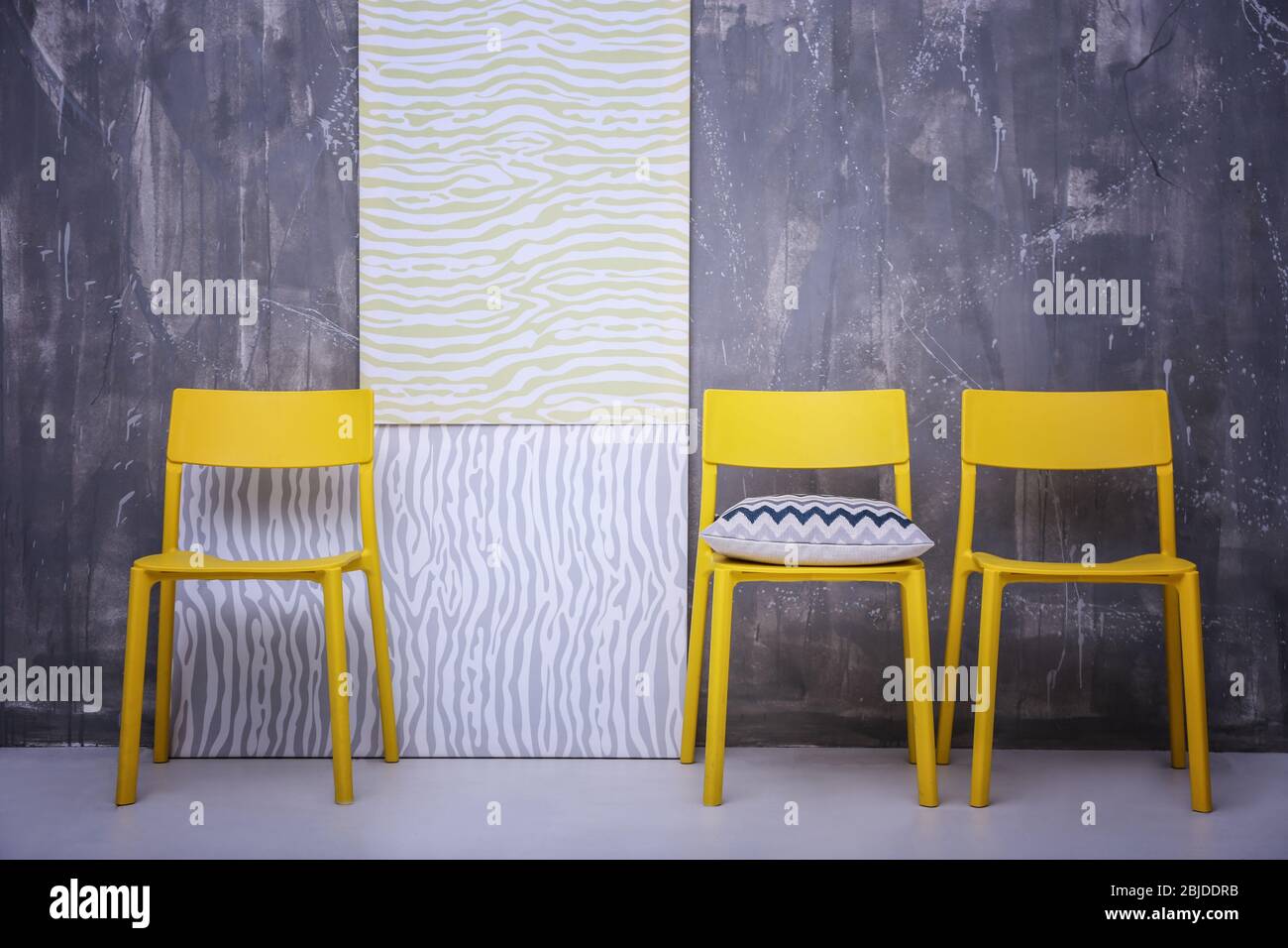 Modern chairs on wall background Stock Photo - Alamy