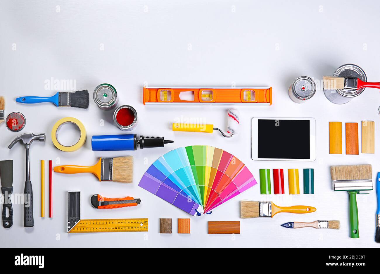 Paint roller with color swatches and other tools on work table Stock ...