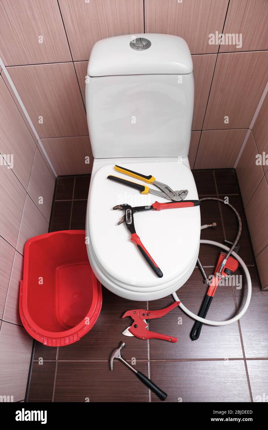 Plumber's tools on toilet at home Stock Photo - Alamy