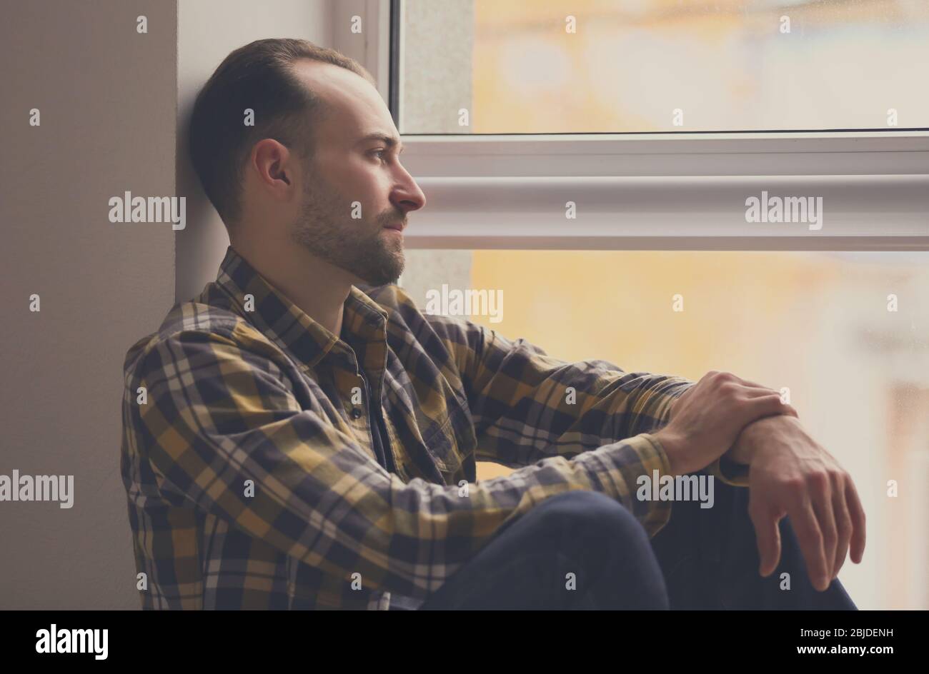 Handsome depressed man sitting hi-res stock photography and images - Alamy