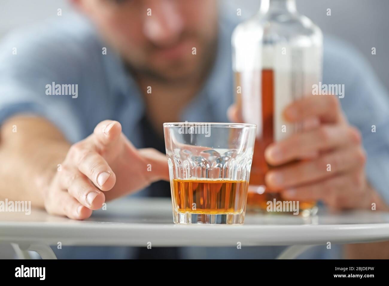 Male hand with glass of whisky, closeup Stock Photo - Alamy