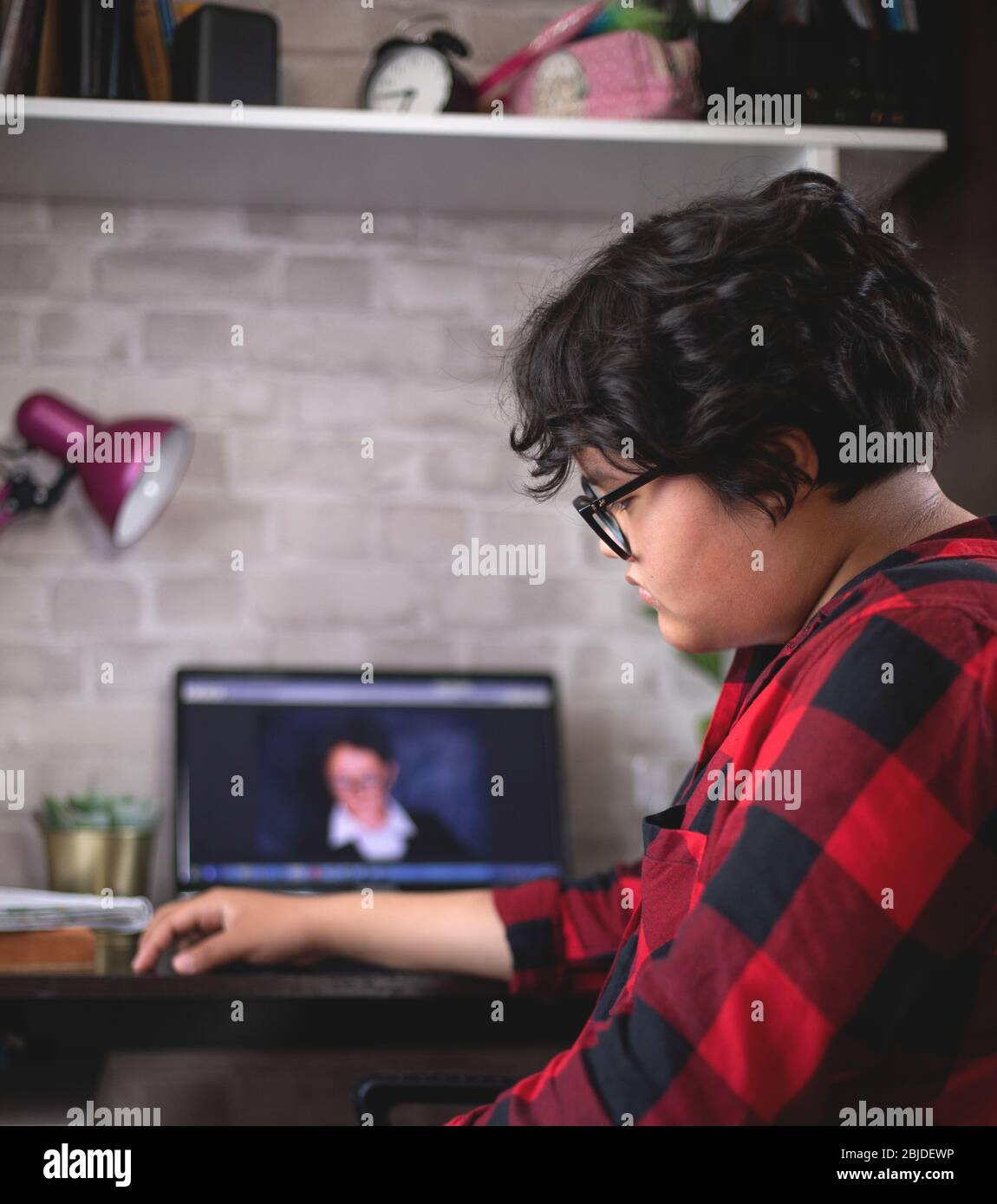 Sad teenage girl is learning remotely Stock Photo - Alamy