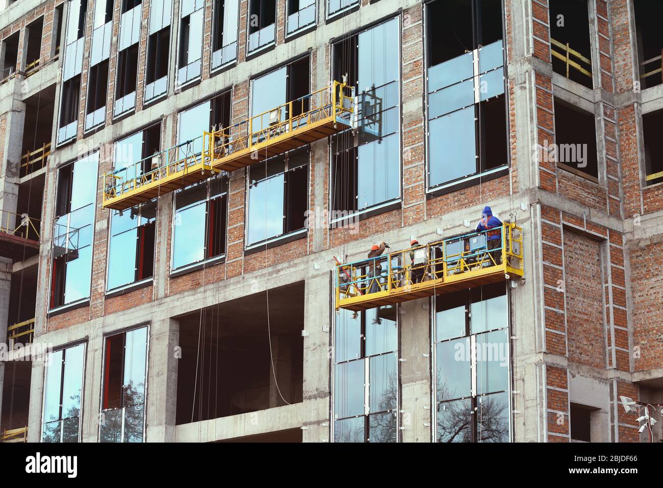 Group of workers installing windows Stock Photo - Alamy