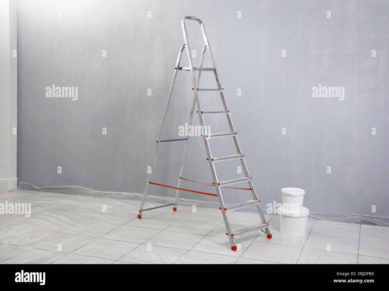 Ladder with paint standing in empty room Stock Photo - Alamy