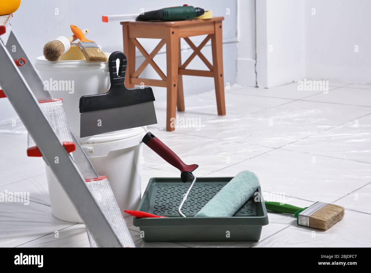 Set for wall painting in empty room Stock Photo - Alamy