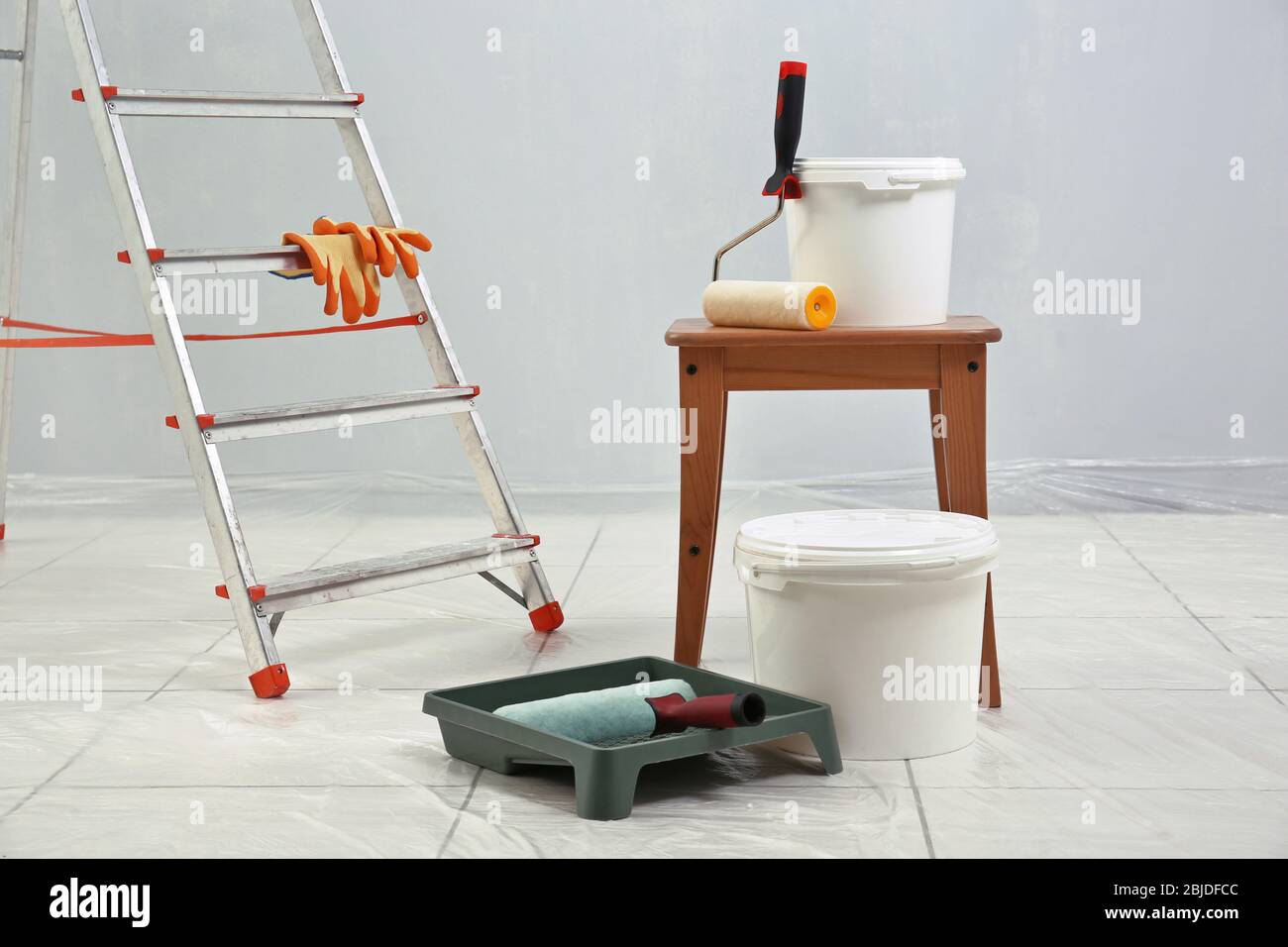 Set for wall painting in empty room Stock Photo - Alamy