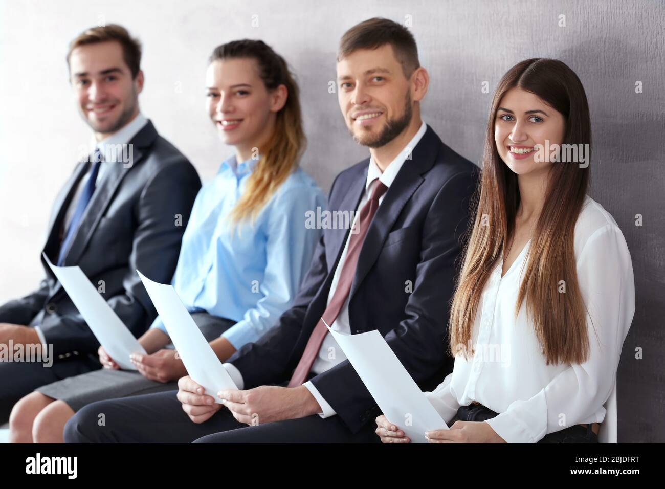 Group of young people waiting for interview indoors Stock Photo - Alamy