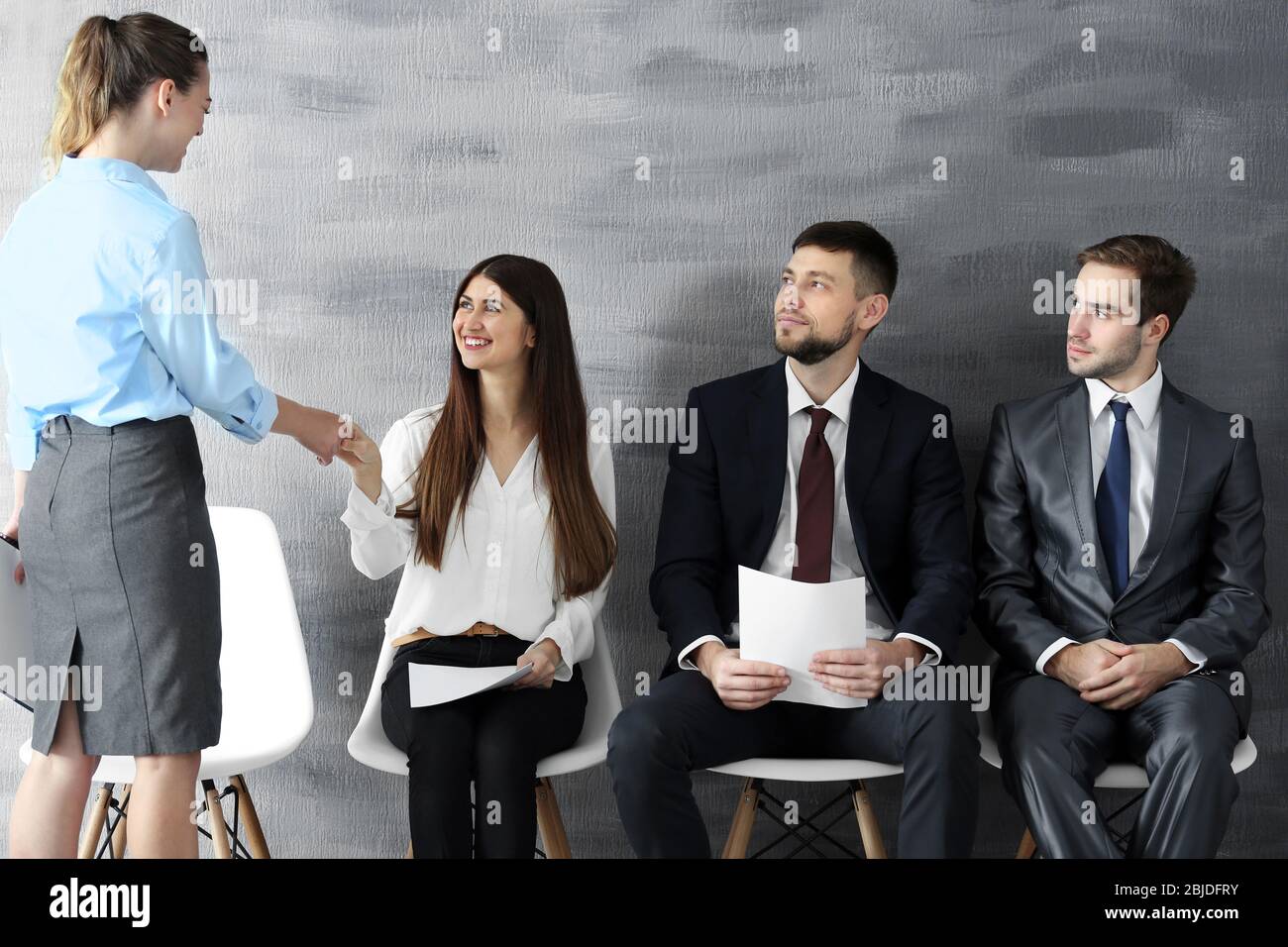 Group of young people waiting for interview indoors Stock Photo - Alamy