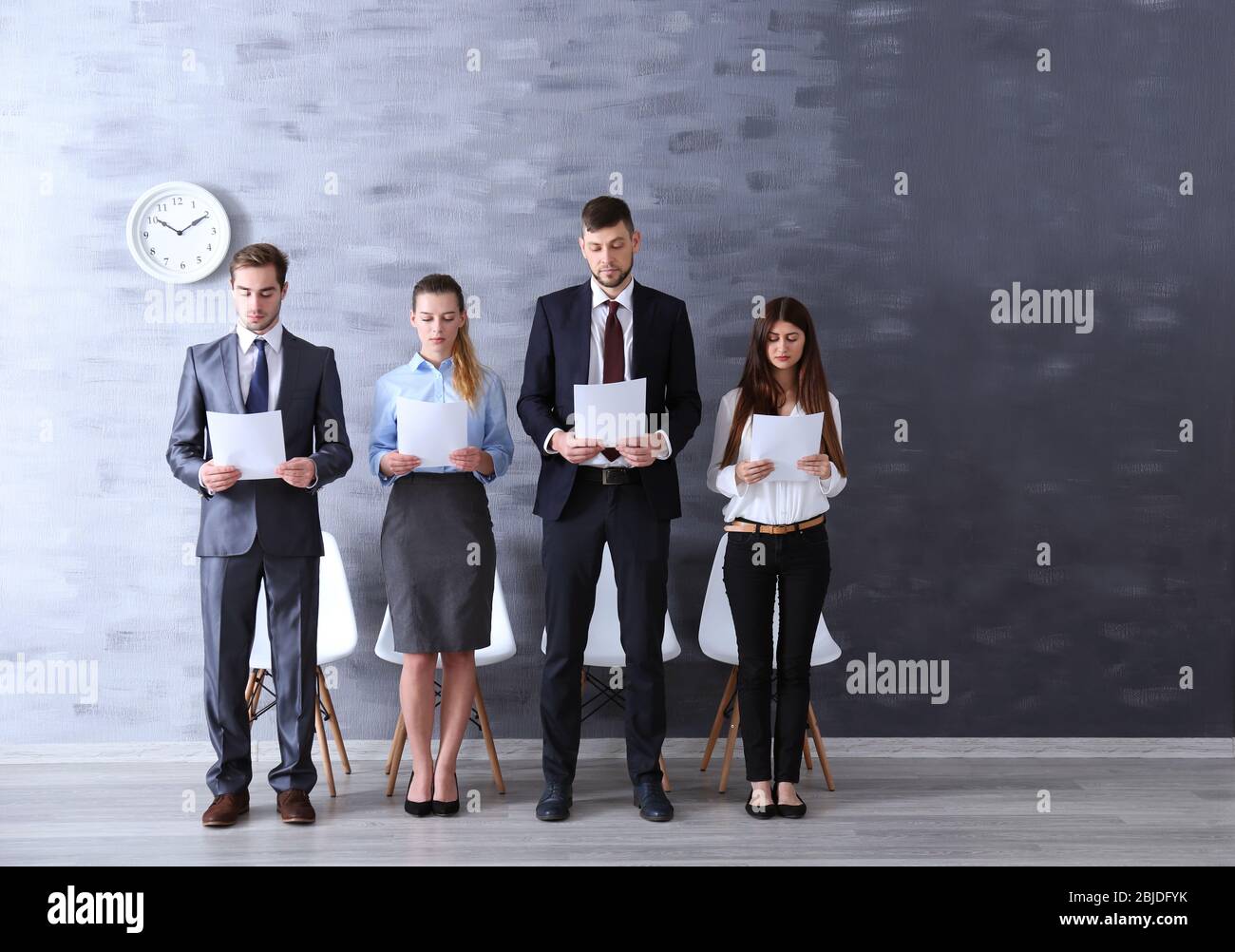Group of young people waiting for interview indoors Stock Photo - Alamy