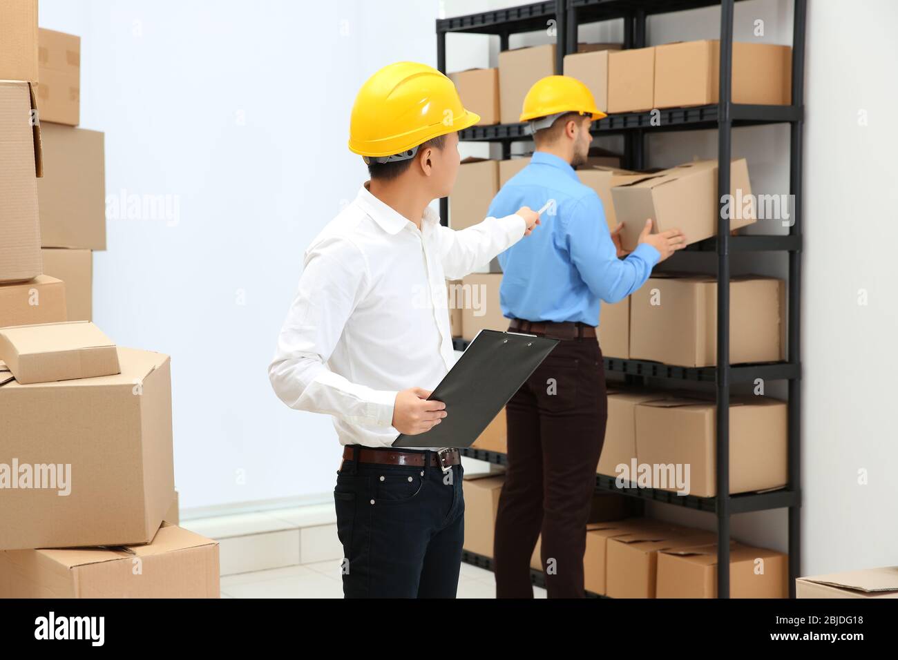 Managers checking orders at warehouse Stock Photo - Alamy